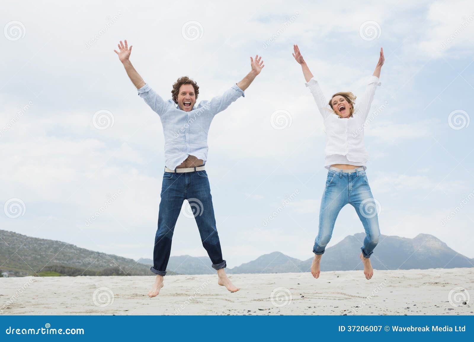 Cheerful Young Couple Jumping at Beach Stock Image - Image of pretty ...