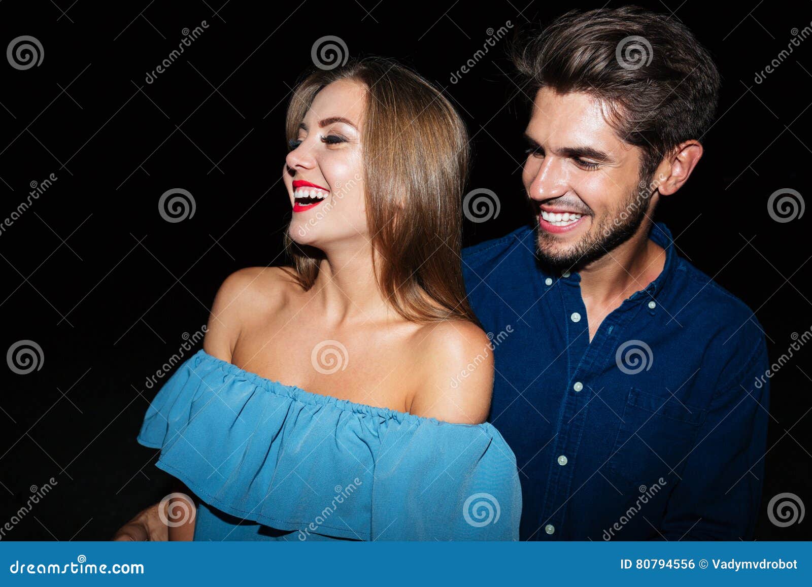 Cheerful Young Couple Laughing Together at Night Stock Photo - Image of ...