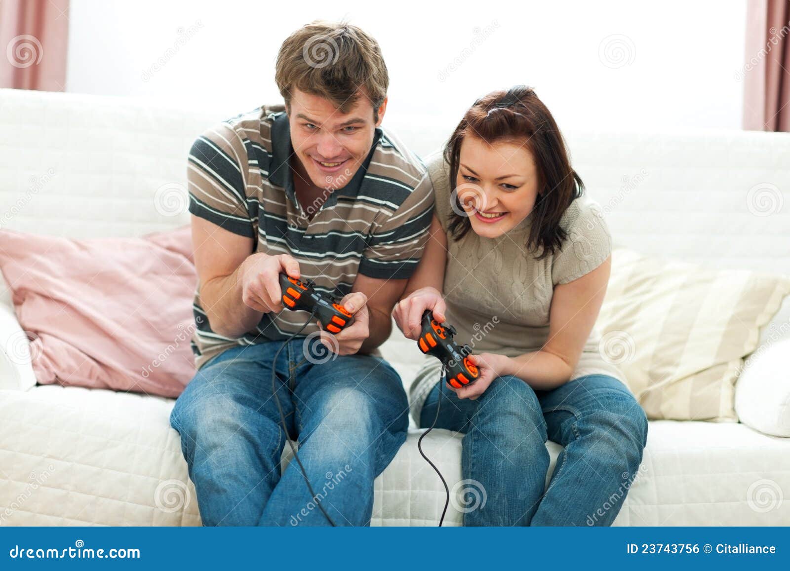Cheerful Young Couple Playing Console Stock Photo - Image of female ...