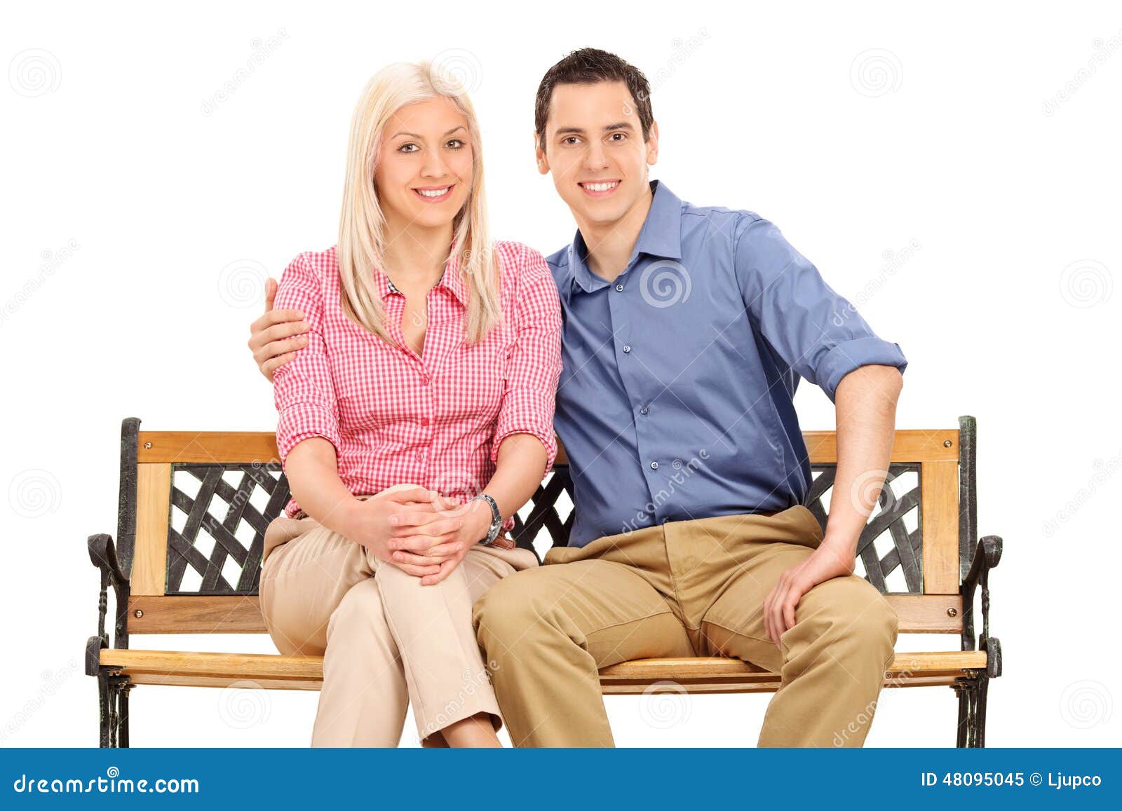 Cheerful Young Couple Posing Seated on a Bench Stock Image - Image of ...
