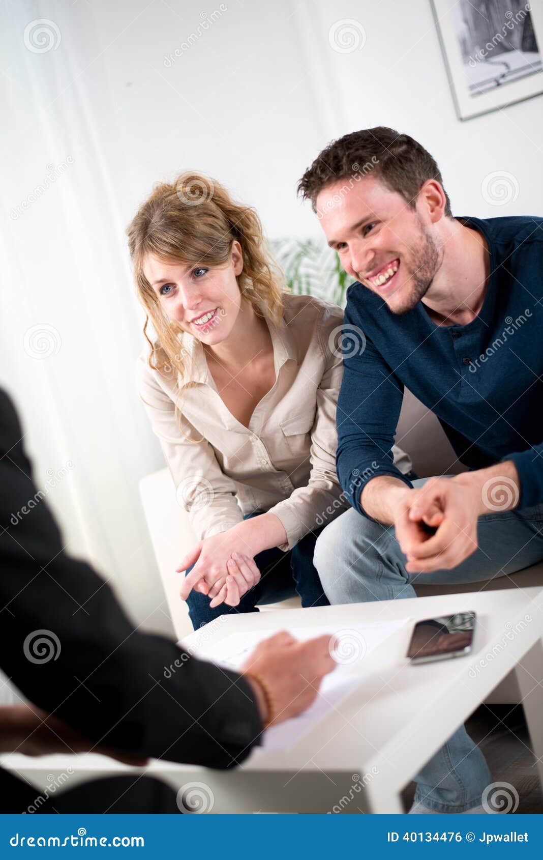 Cheerful Young Couple with Salesman Agent at Home Stock Photo - Image ...