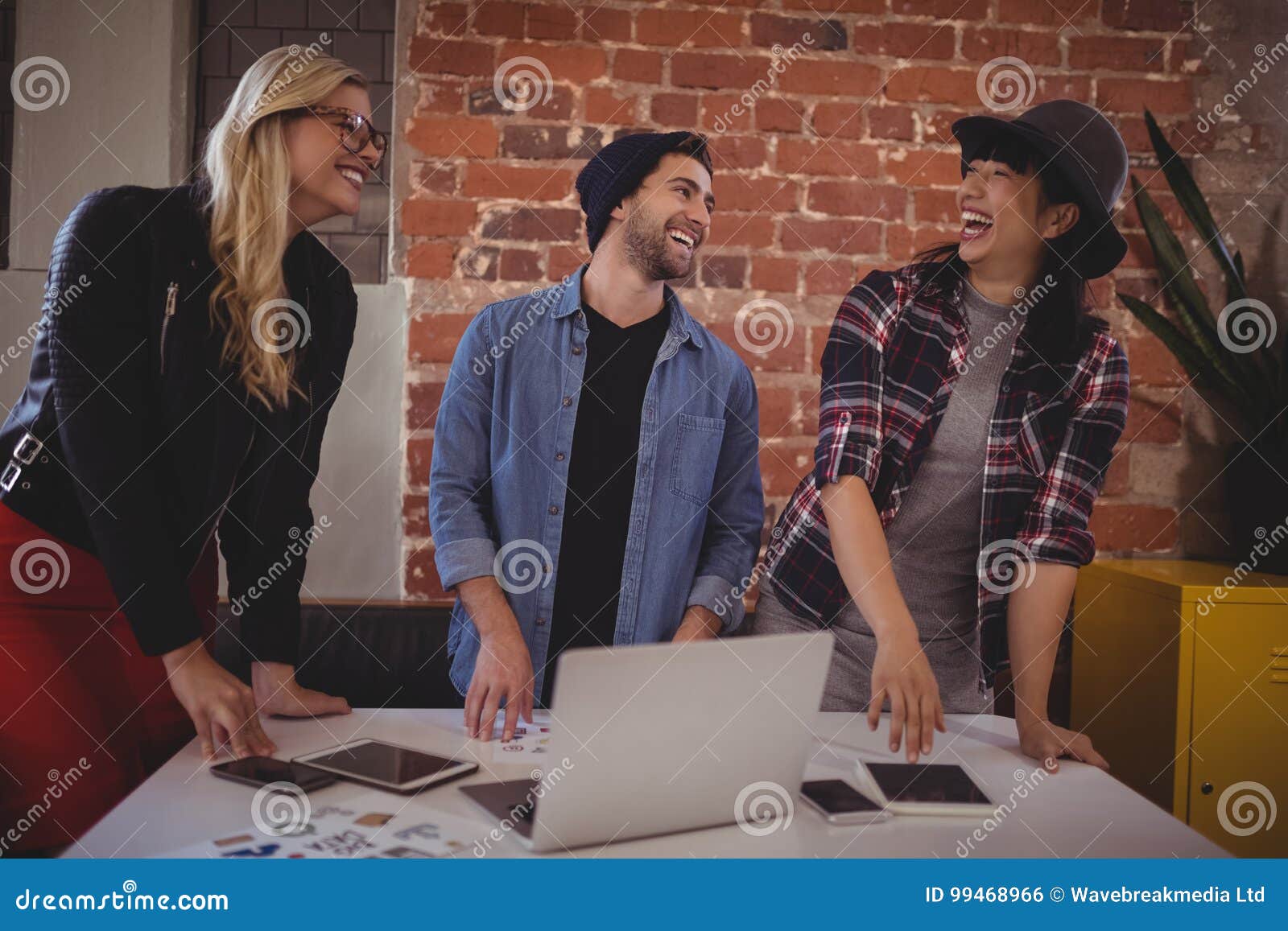 Cheerful Young Creative Team Using Technologies at Coffee Shop Stock ...