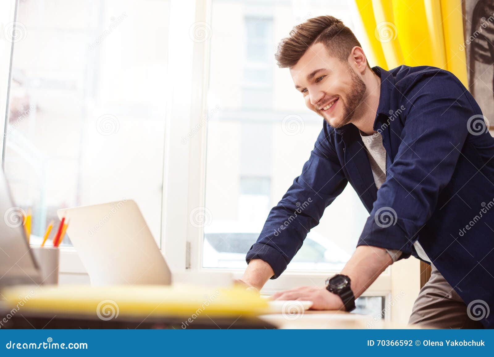 Cheerful Young Guy is Working with a Laptop Stock Photo - Image of ...