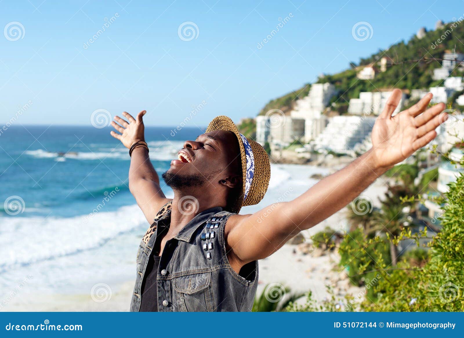 Cheerful Young Man with Arms Spread Open at the Beach Stock Photo ...