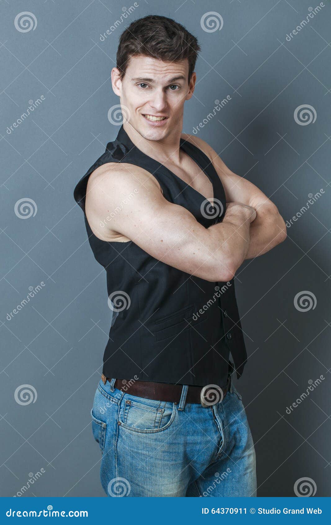 Cheerful Young Man Crossing Big Muscular Arms Showing Male Satisfaction ... Cheerful Young Man Crossing Big Muscular Arms Showing Male Satisfaction ...