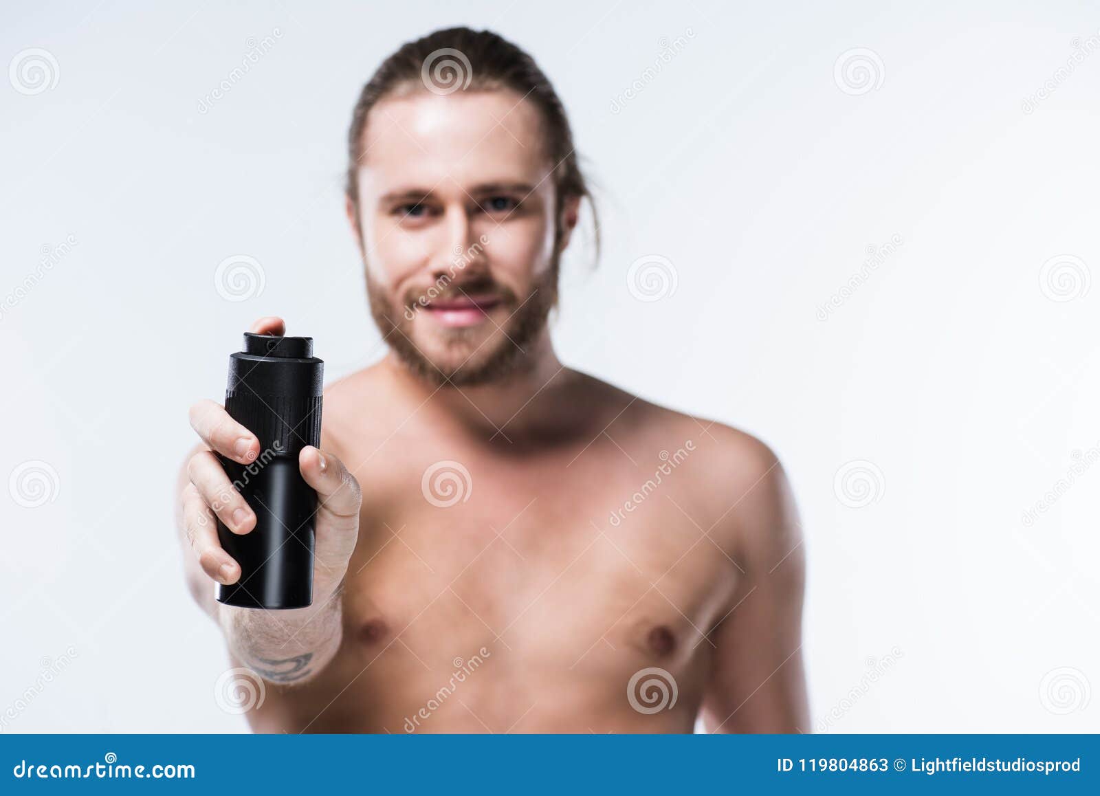 Cheerful Young Man Holding Deodorant Spray in Outstretched Stock Image ...