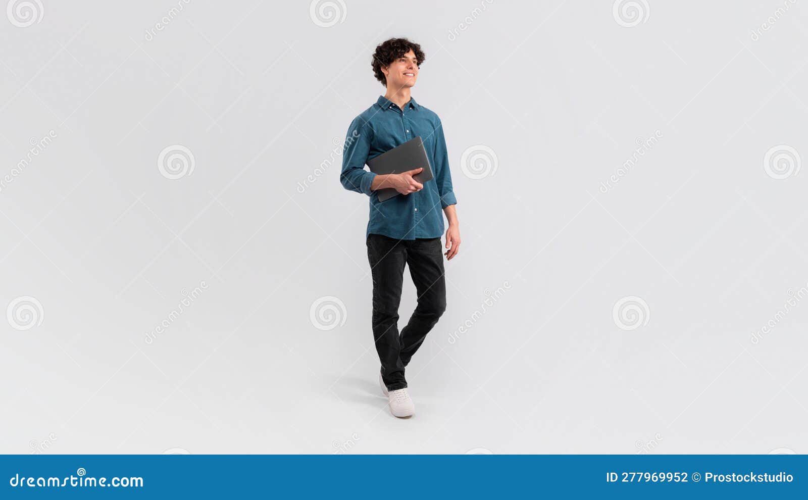 Cheerful Young Man Holding Laptop Computer Standing in Studio Stock ...