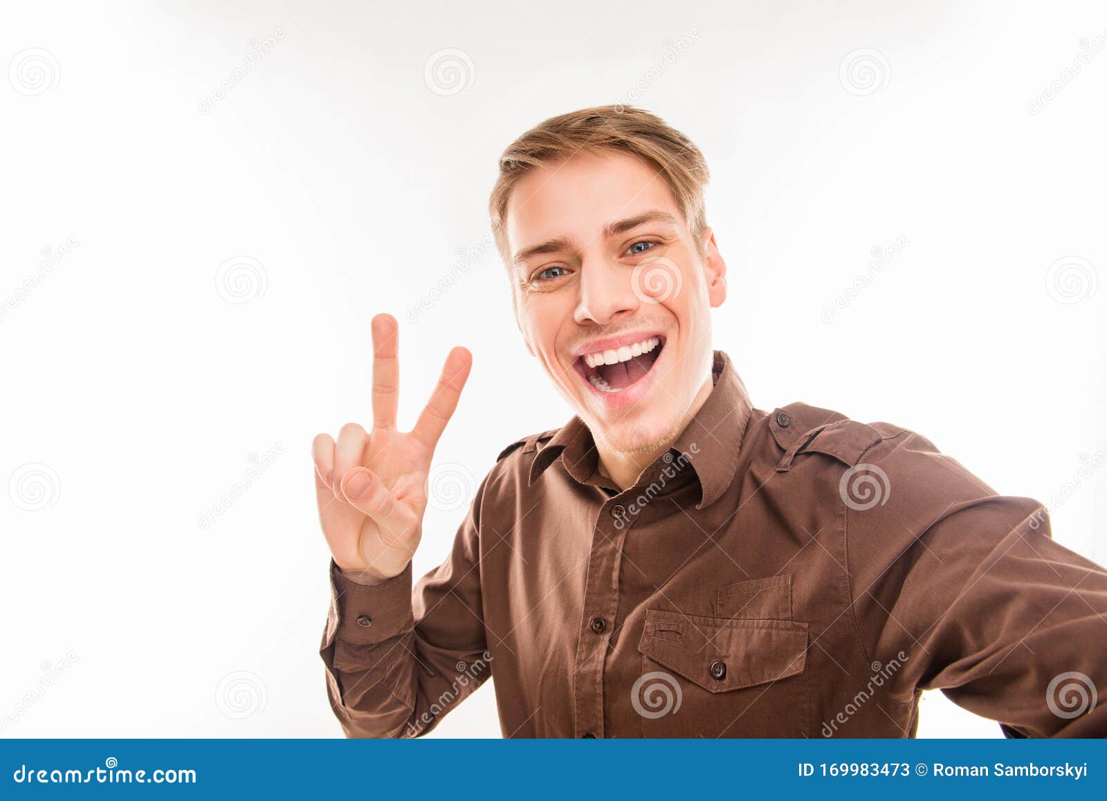 Cheerful Young Man Making Selfie and Gesturing with Two Fingers Stock ...