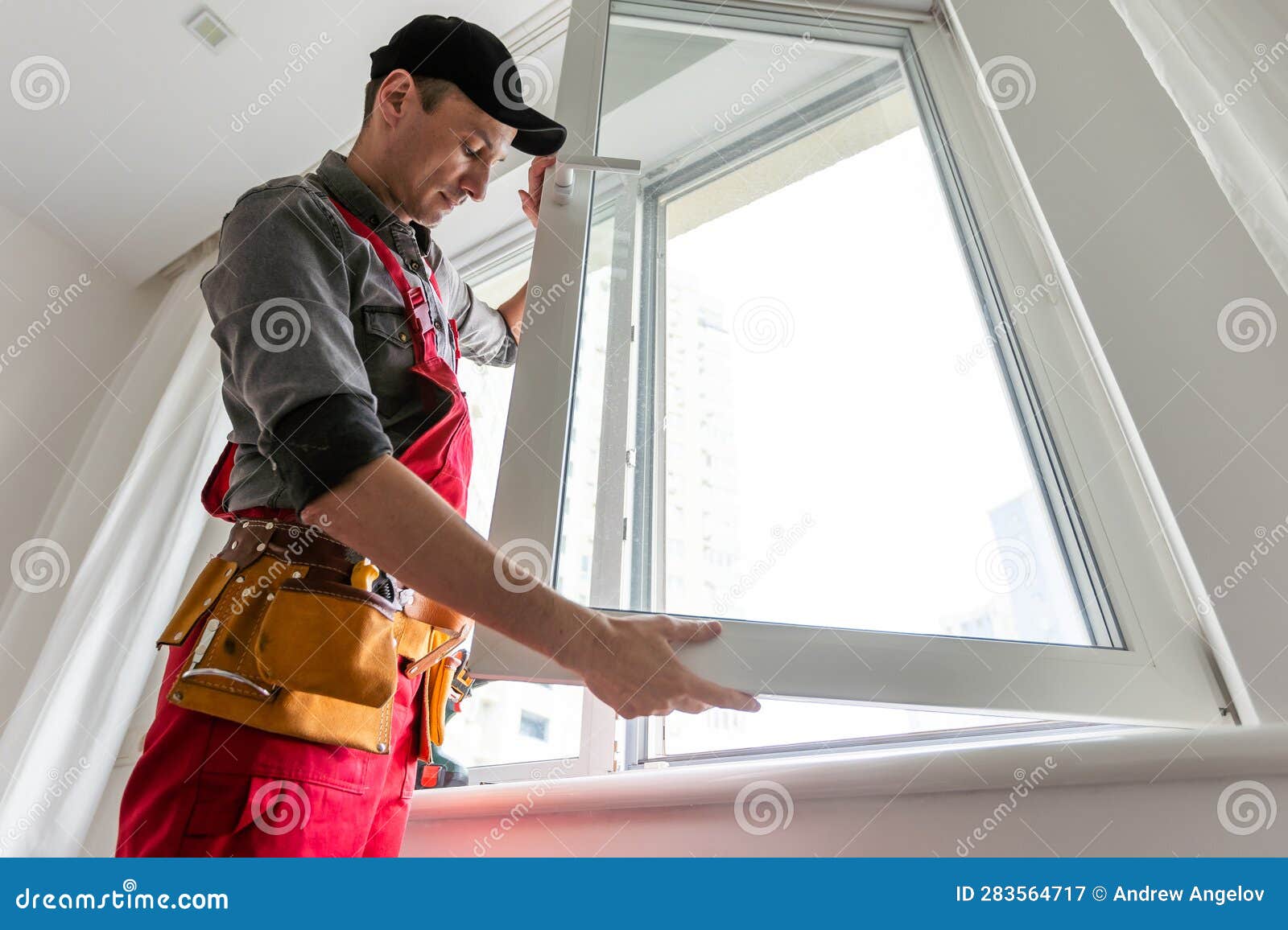 Cheerful Young Man Mounting a Kitchen Window Stock Image - Image of ...