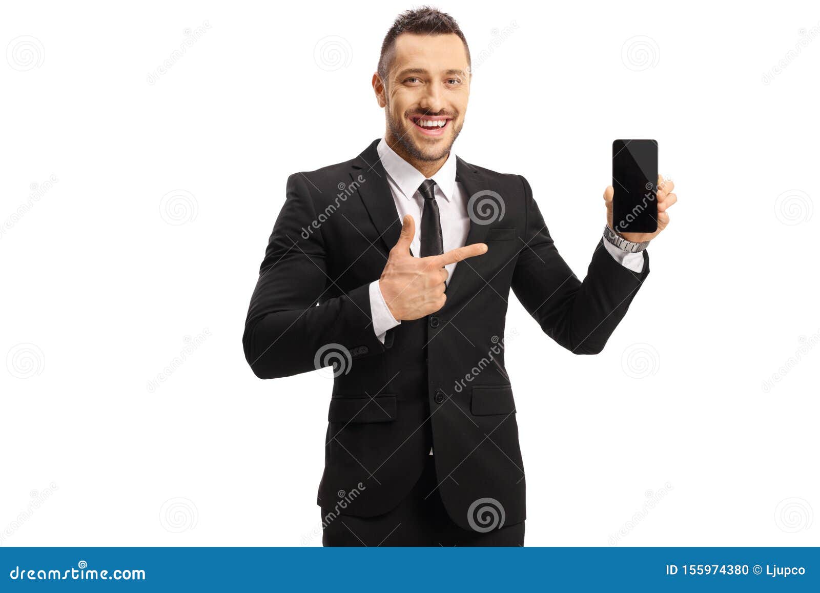 Cheerful Young Man in a Suit Holding a Mobile Phone and Pointing at it ... Cheerful Young Man in a Suit Holding a Mobile Phone and Pointing at it ...