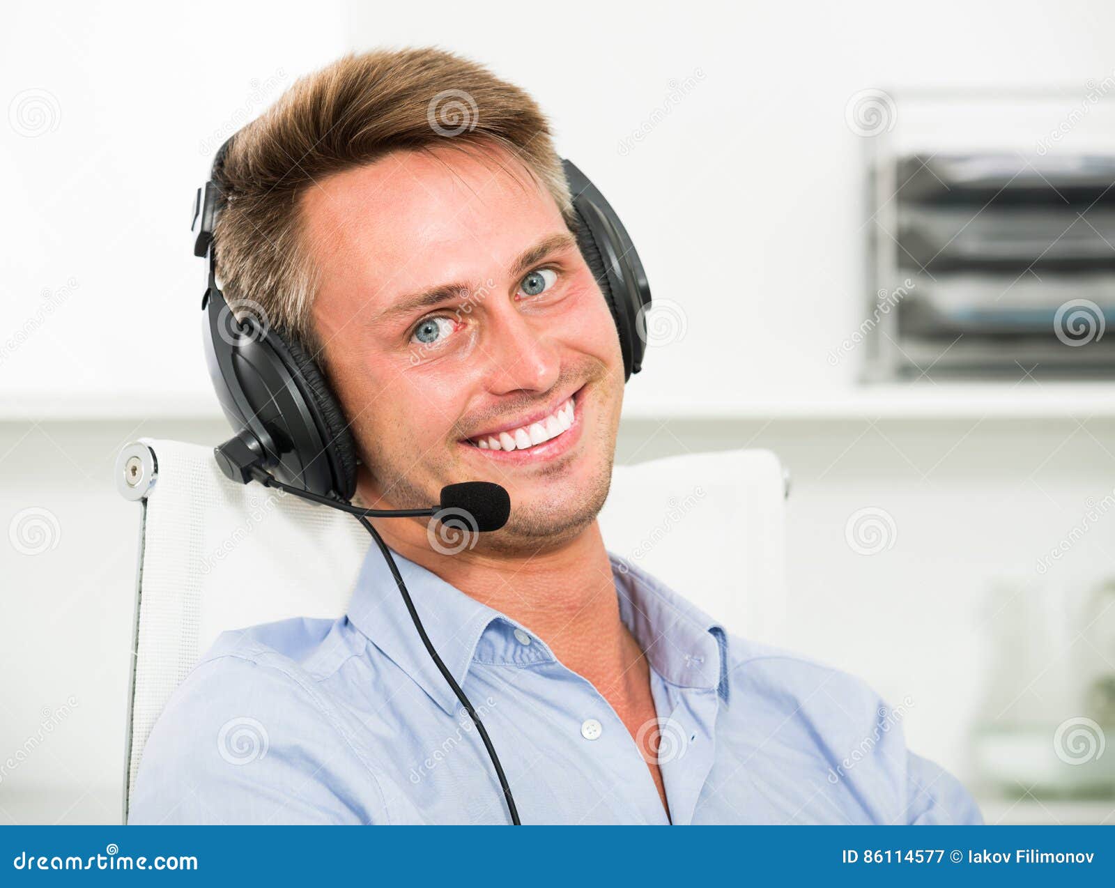 Cheerful Young Man Talking on Headset at Office Stock Image - Image of ...