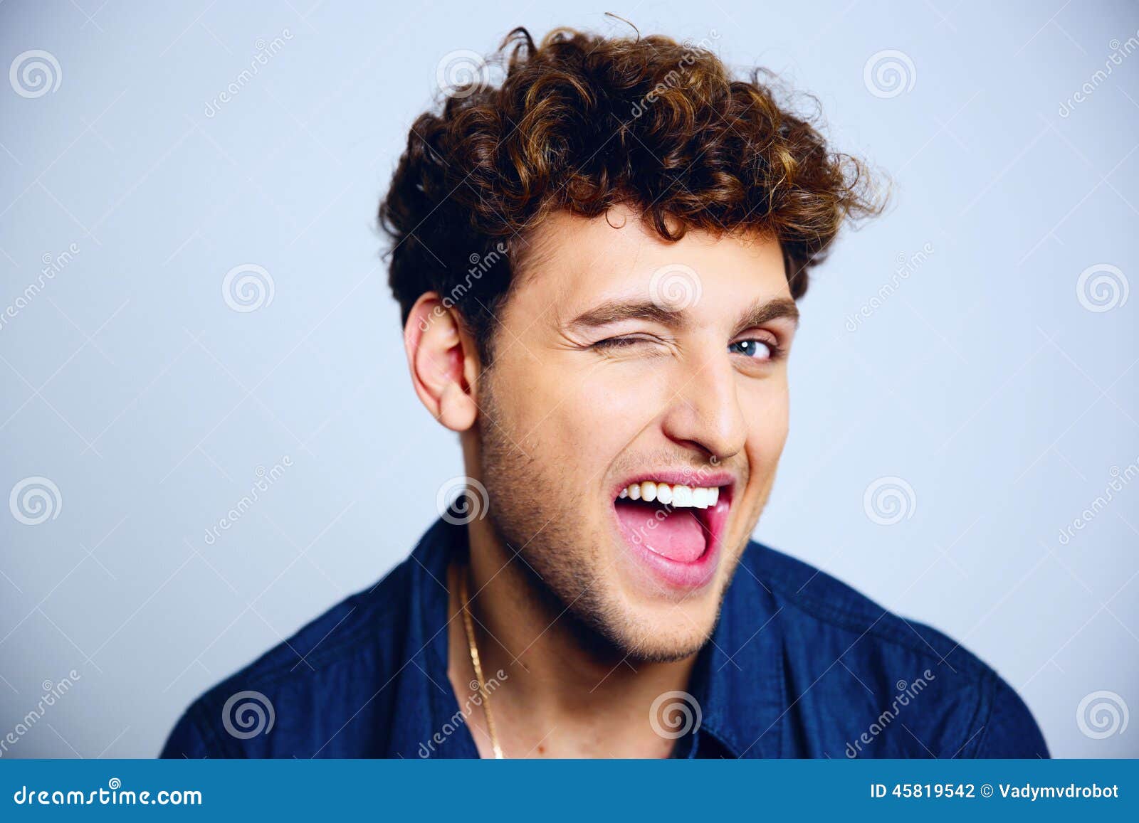 Cheerful young man winking stock photo. Image of wink - 45819542