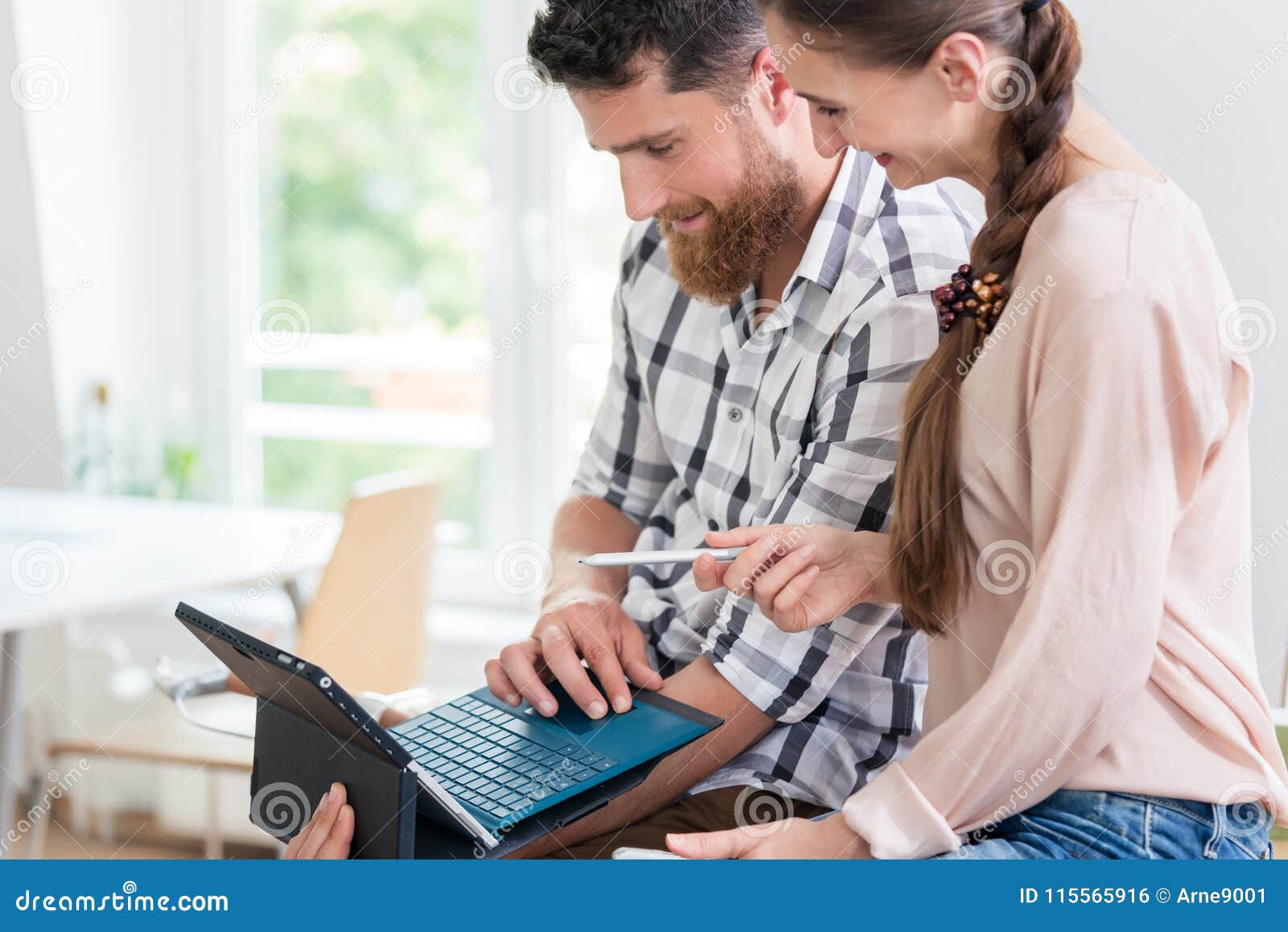 Cheerful Young Man Collaborating with His Female Co-worker Stock Photo ...