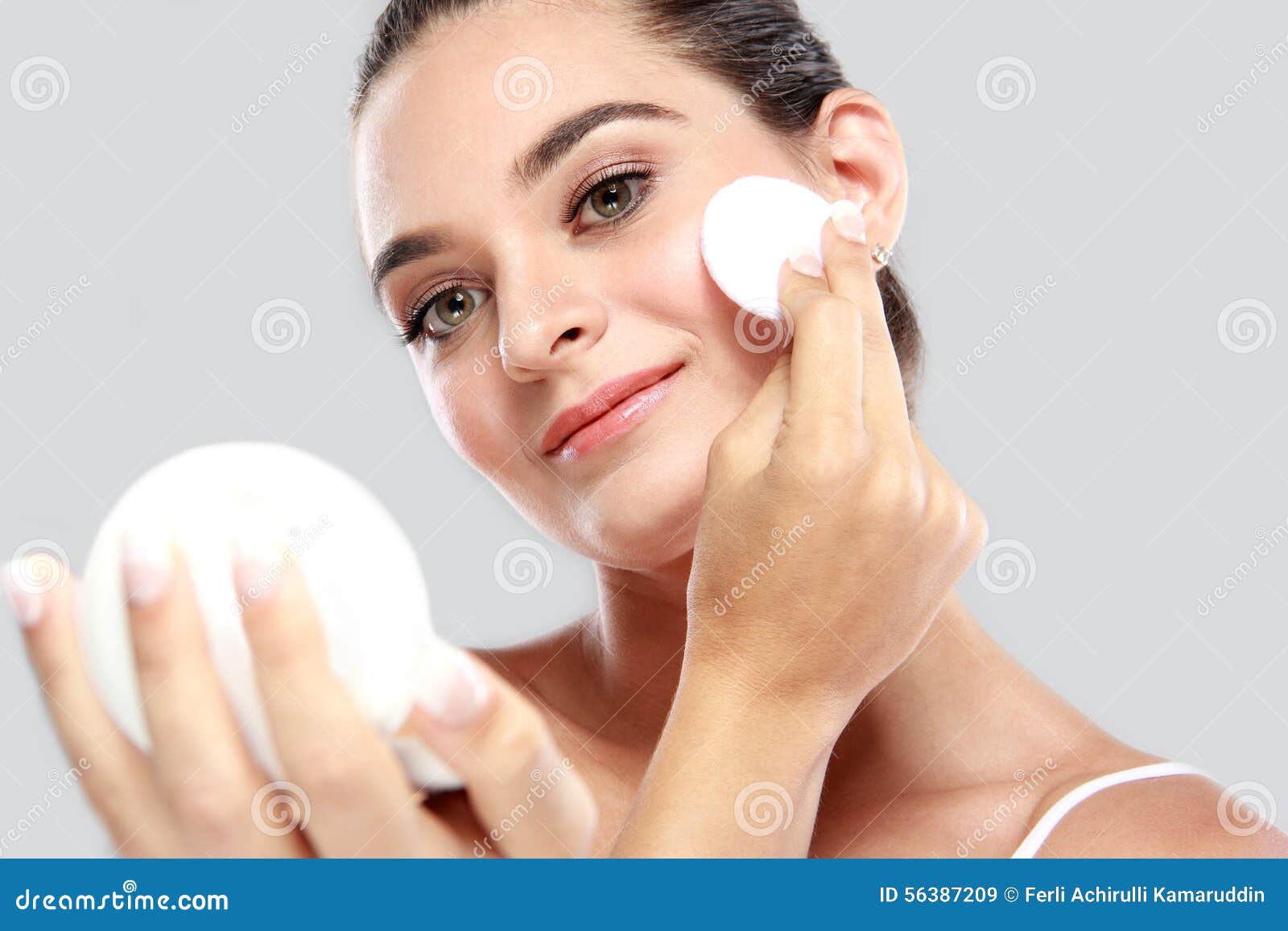 Cheerful Young Model Smiling while Holding a Compact Powder and Stock ...