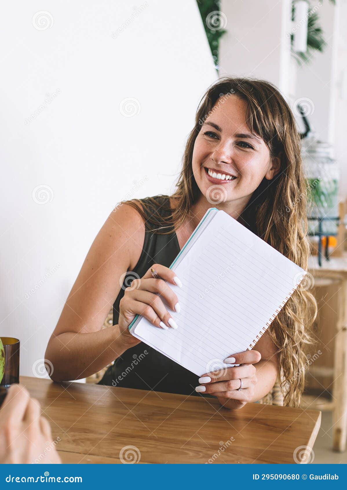 Cheerful Young Pretty Woman Holding Notepad while Siting with Man ...