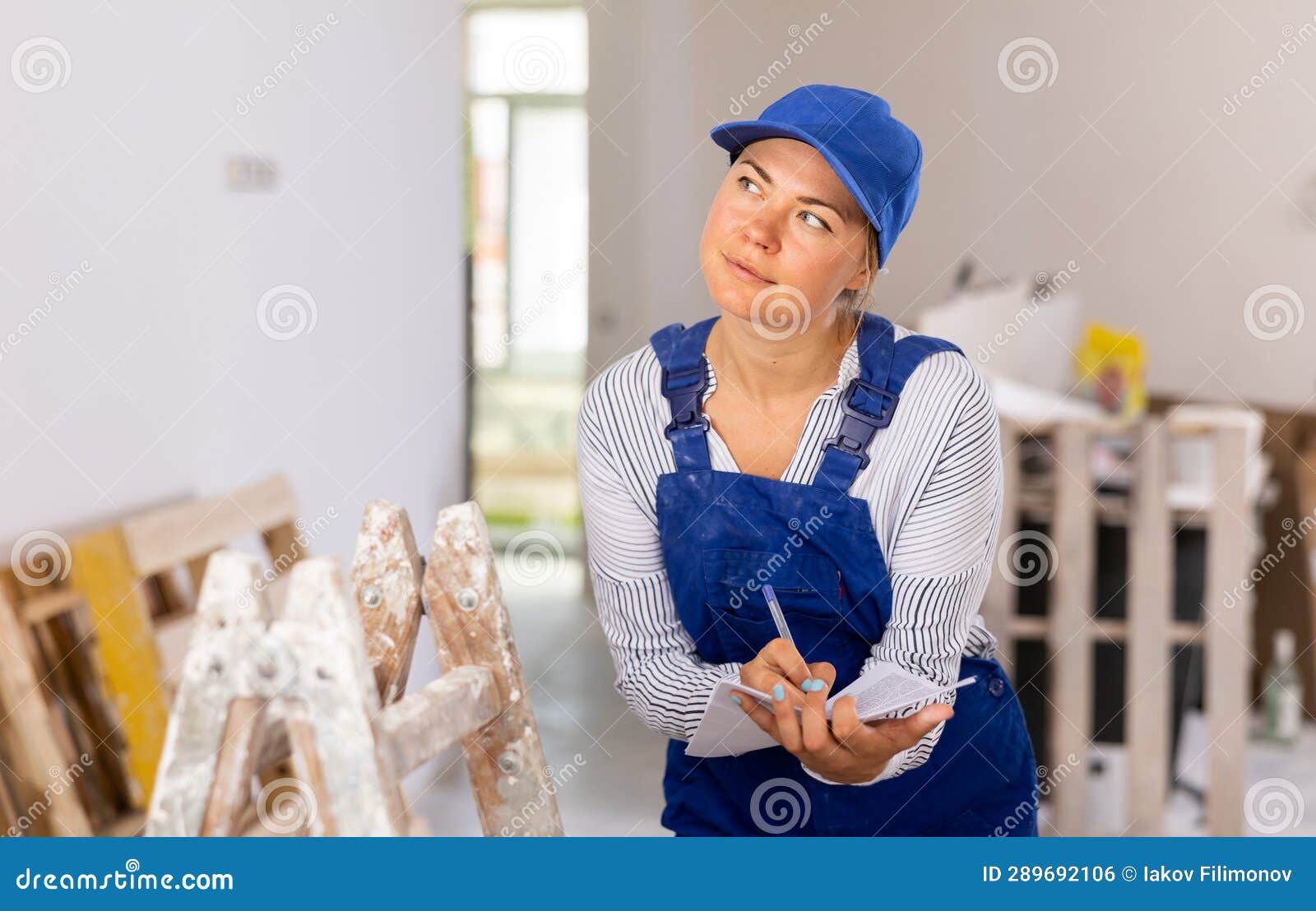 Cheerful Young Woman Builder Checking Project Documentation Stock Photo - Image of construction ...