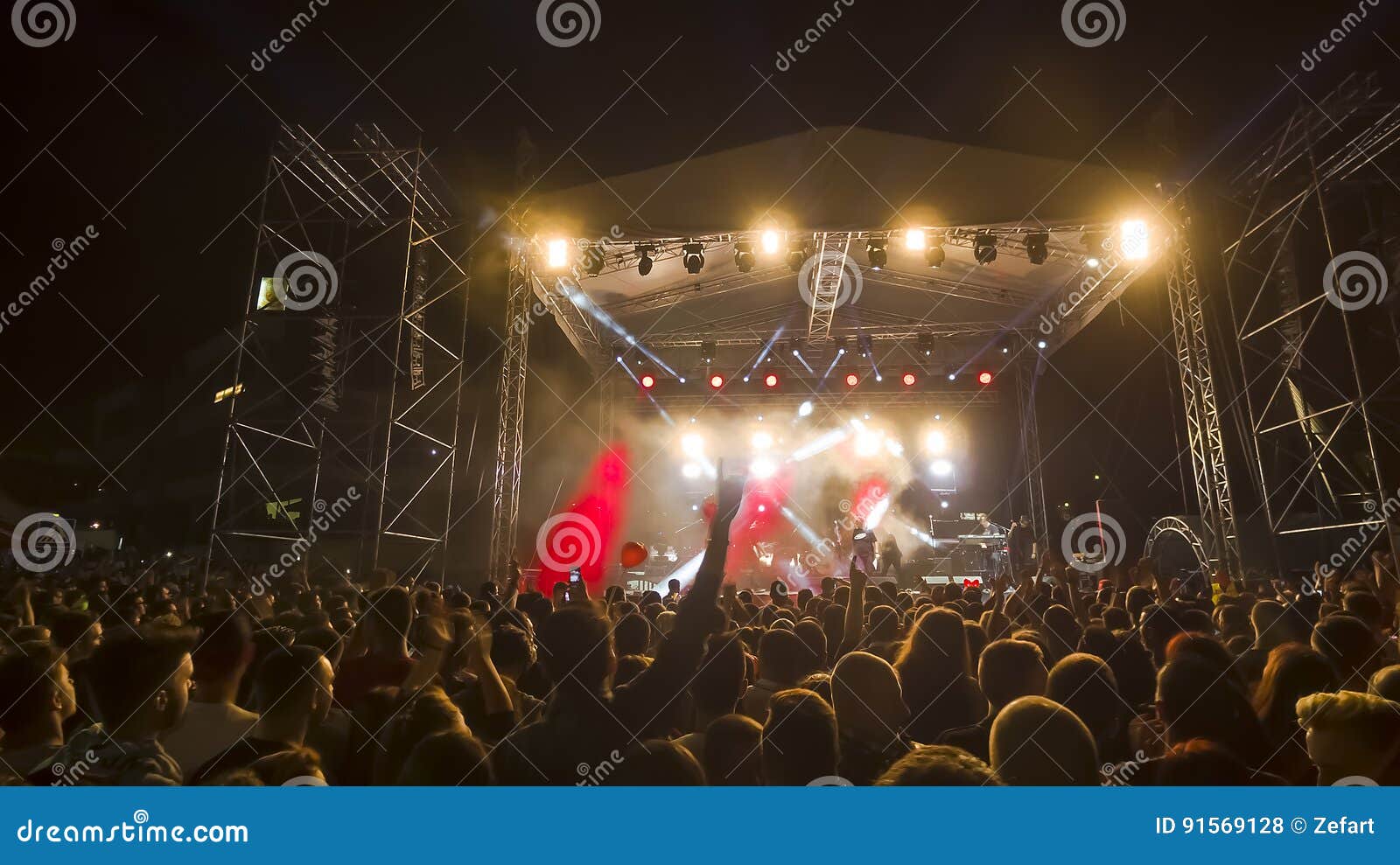 Cheering Crowd in Front of Bright Colorful Stage Lights Editorial Stock ...