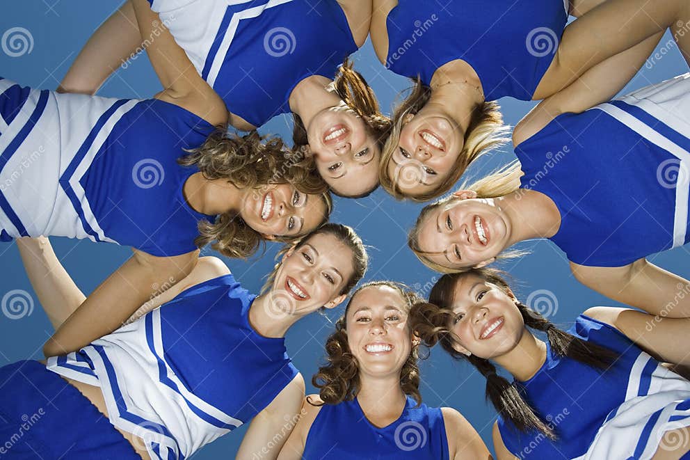 Cheerleaders Forming Huddle Stock Photo - Image of smiling, exciting ...