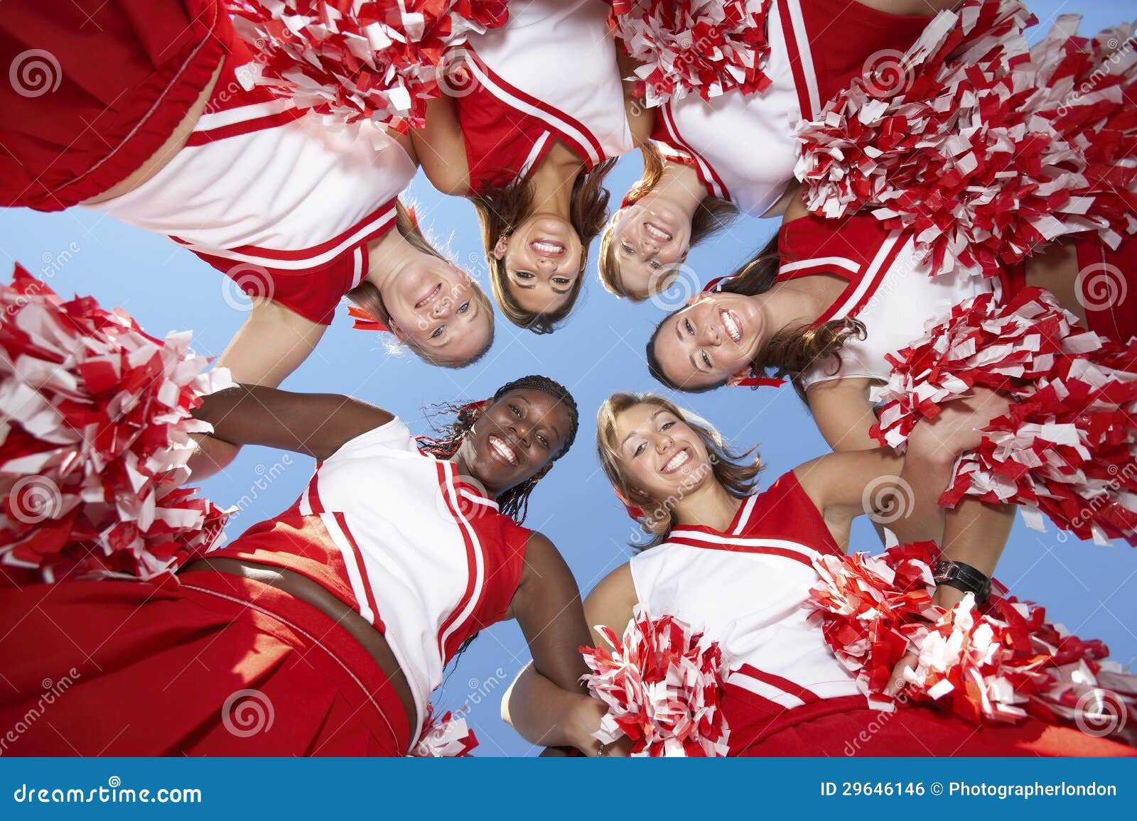 Cheerleaders Forming a Huddle Stock Photo - Image of outdoors, ethnic ...