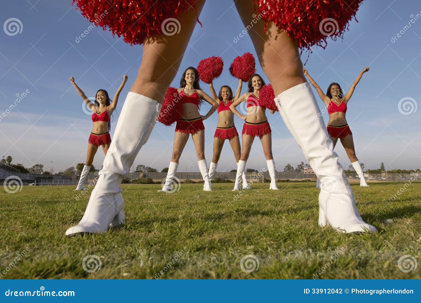 Cheerleaders Performing on Field Stock Photo - Image of pompom, full ...
