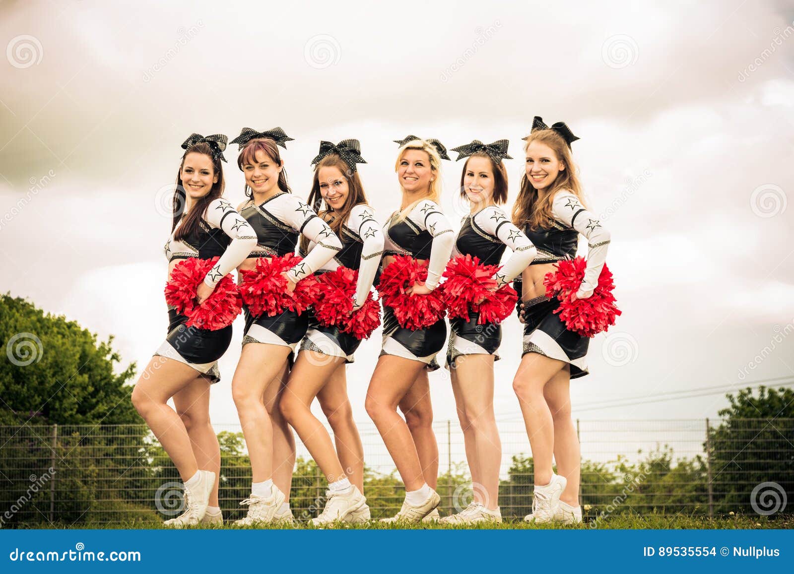 Cheerleaders Rooting for Their Team Stock Photo - Image of sports ...