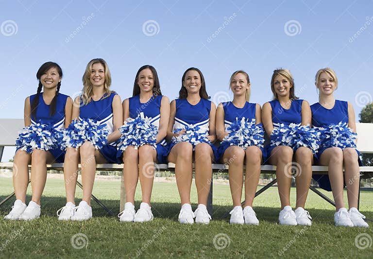 Cheerleaders Sitting on Bench Stock Image - Image of young, girl: 13584657