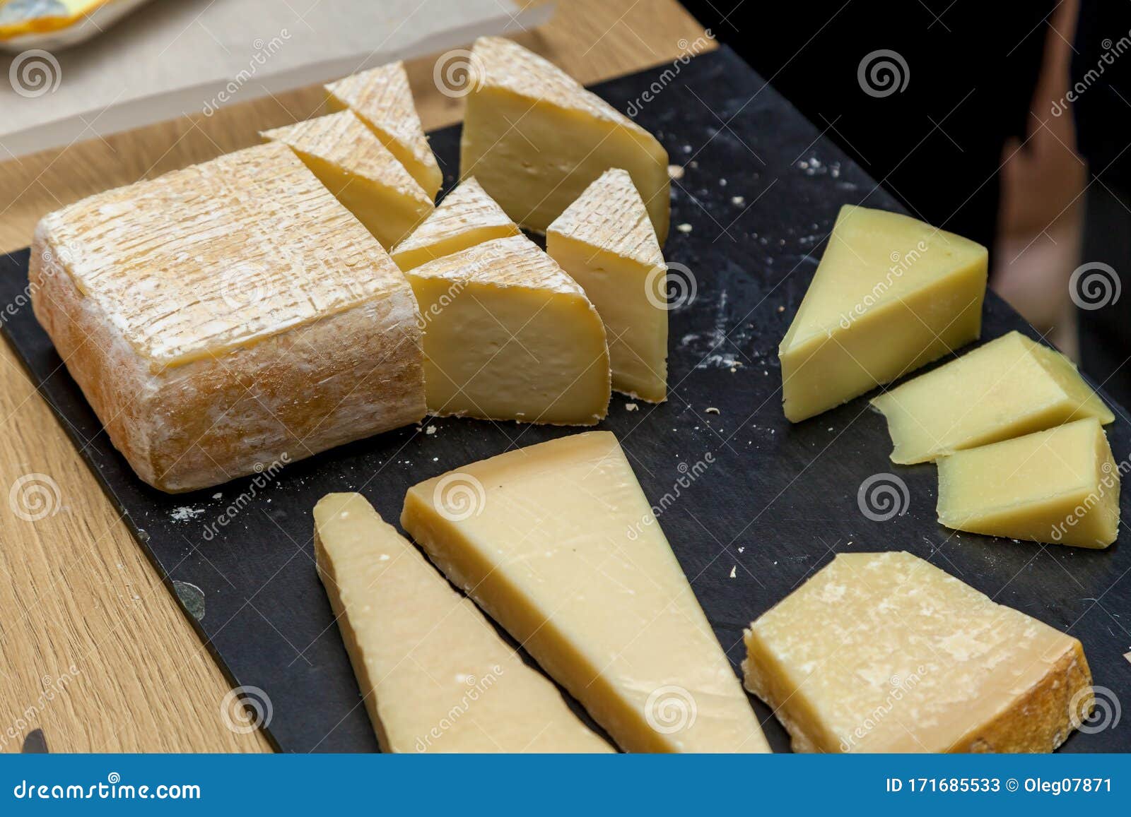 A Cheese Cutting from Different Types of Cheese on a Wooden Board Stock ...