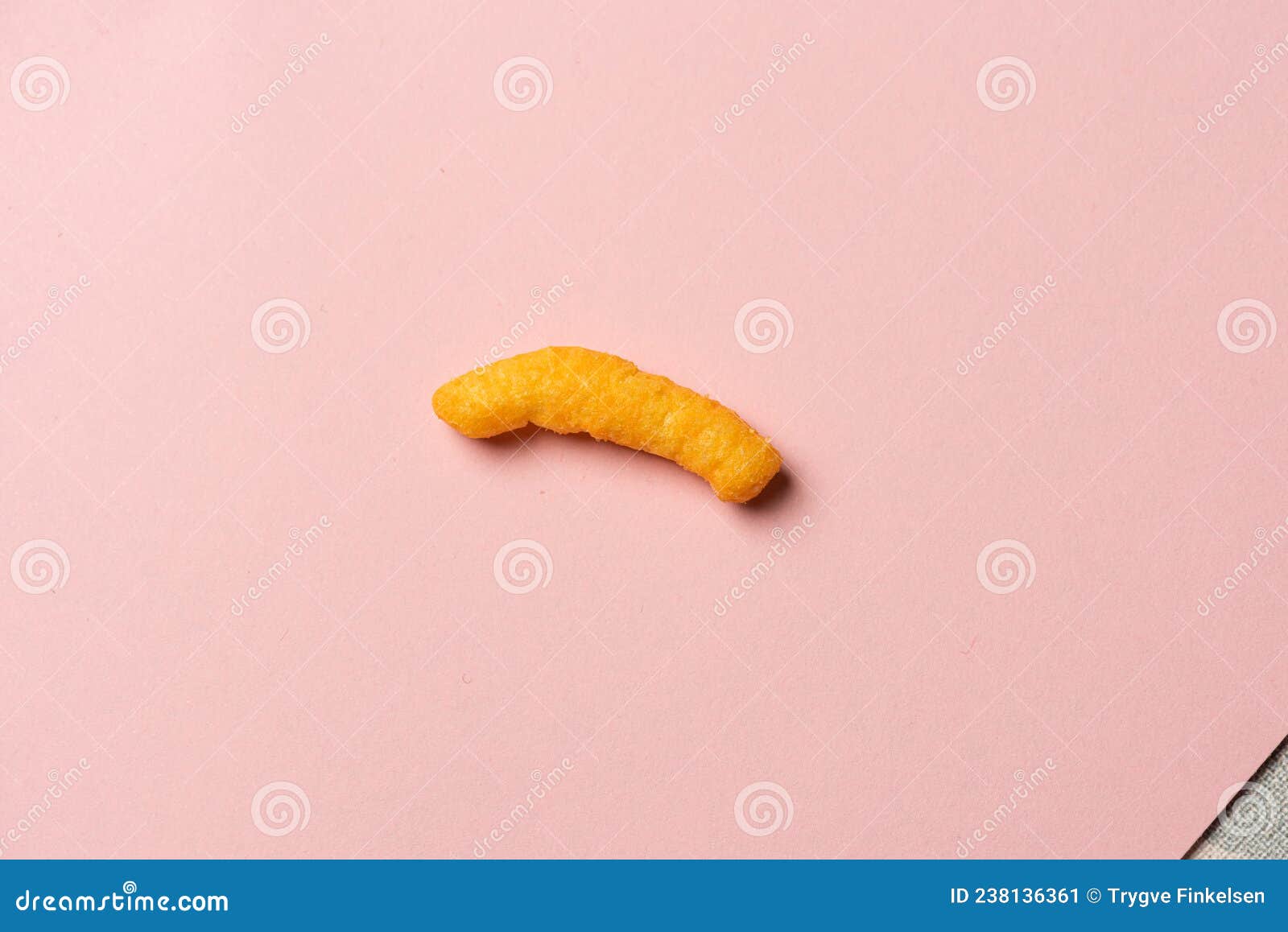 A Cheese Doodle on Pink Background Stock Image - Image of background ...