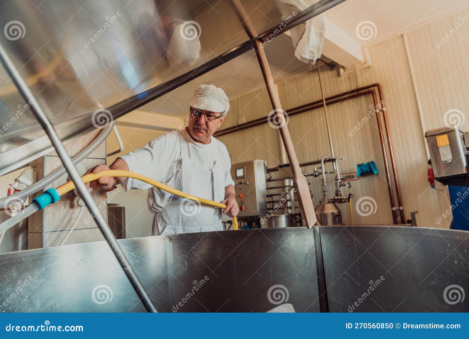 A Cheese Makser Working in the Industry on Various Machines with the ...