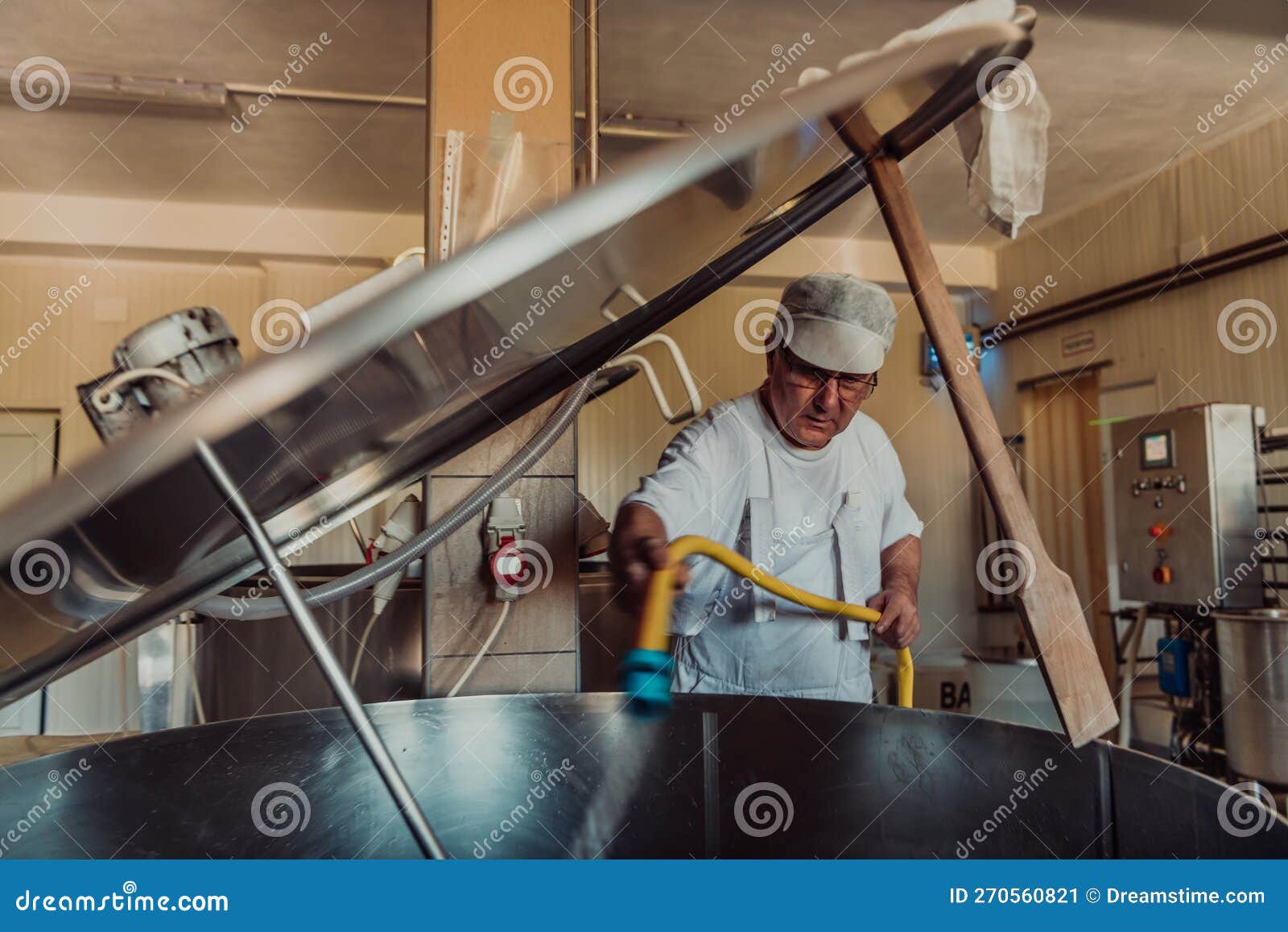 A Cheese Makser Working in the Industry on Various Machines with the ...