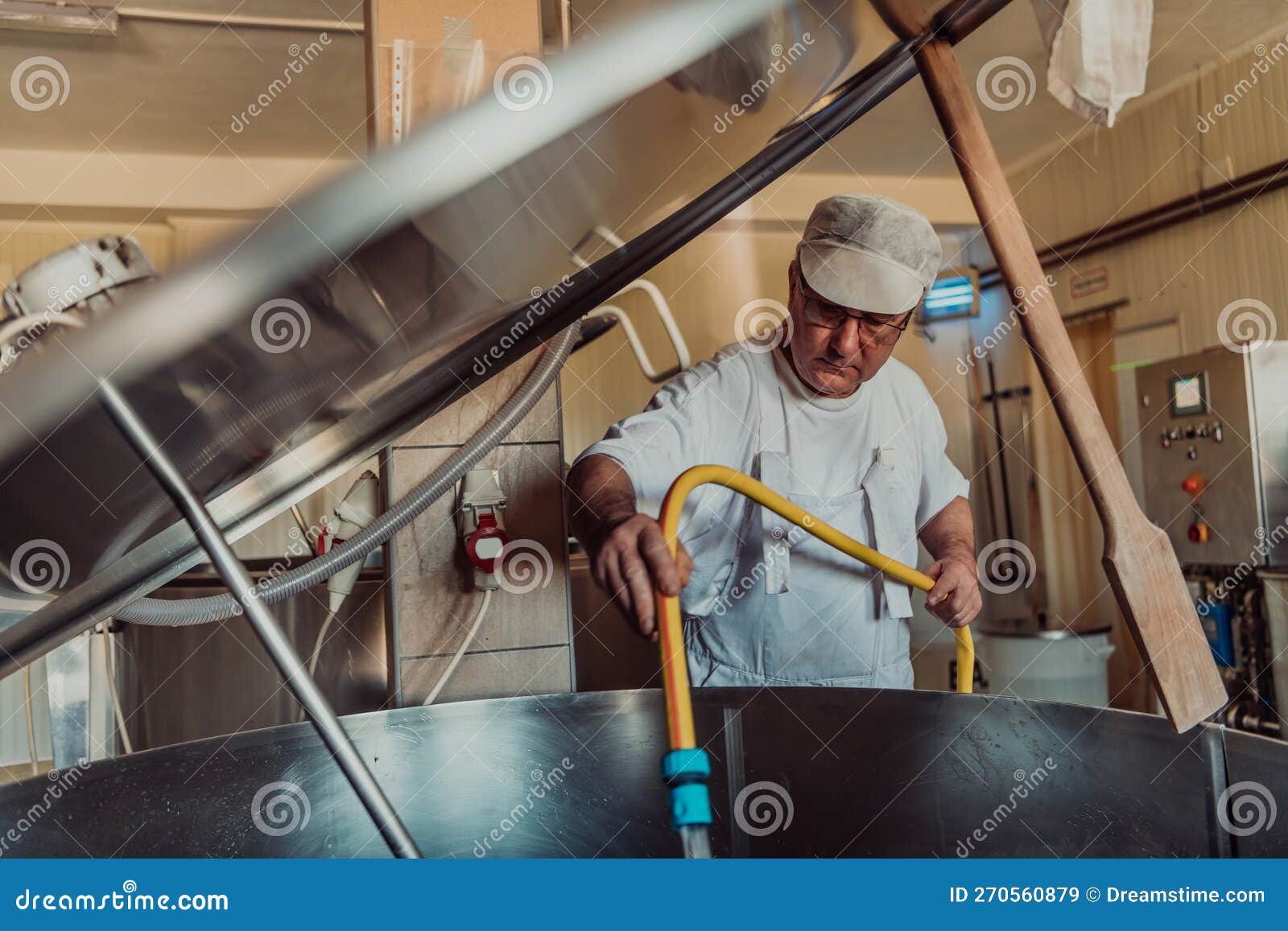 A Cheese Makser Working in the Industry on Various Machines with the ...