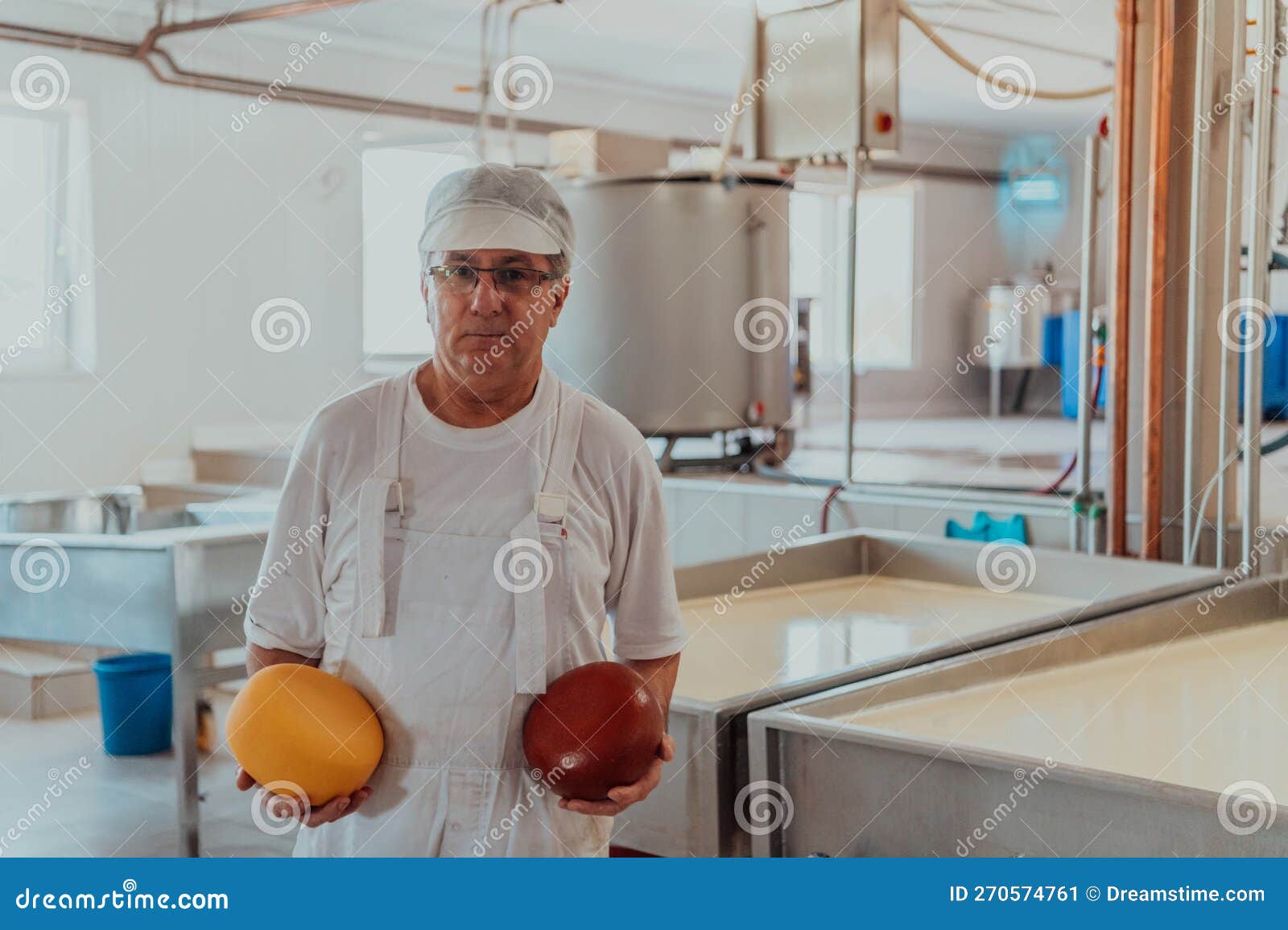 A Cheese Makser Working in the Industry on Various Machines with the ...