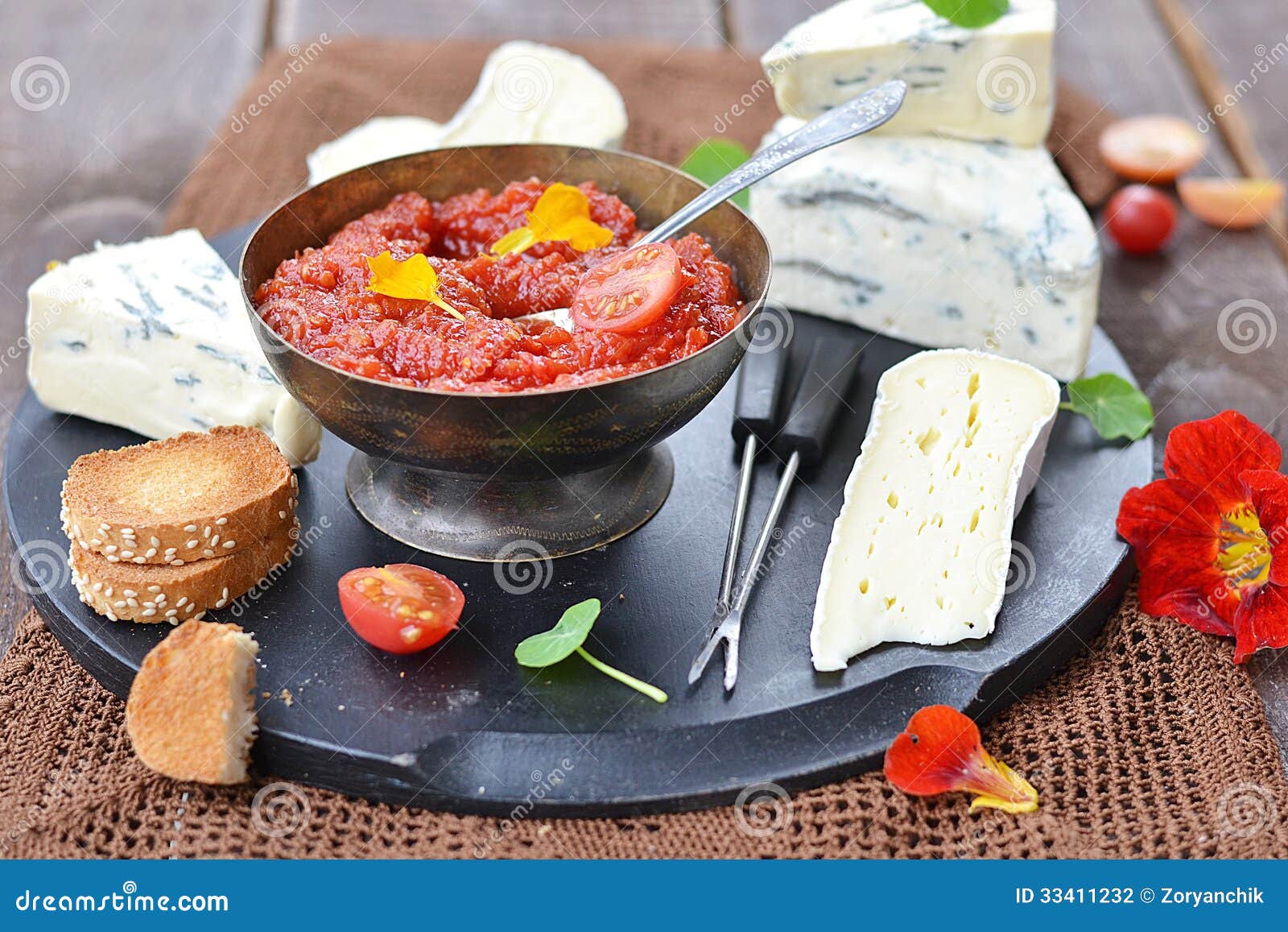 Cheese Plate with Tomato Chutney Stock Photo - Image of board, milk ...