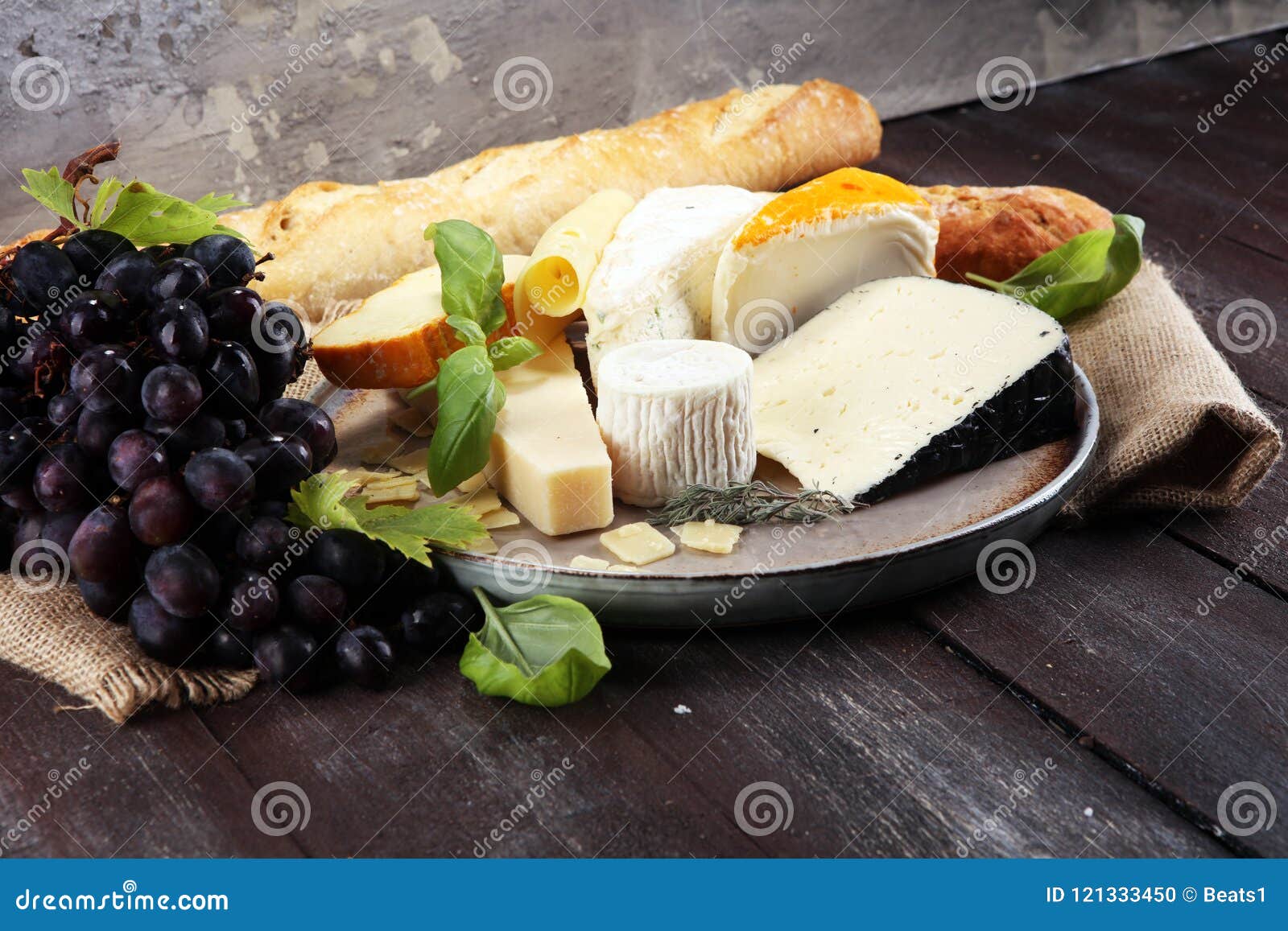 Cheese Platter with Different Cheese on Rustic Plate Stock Photo ...