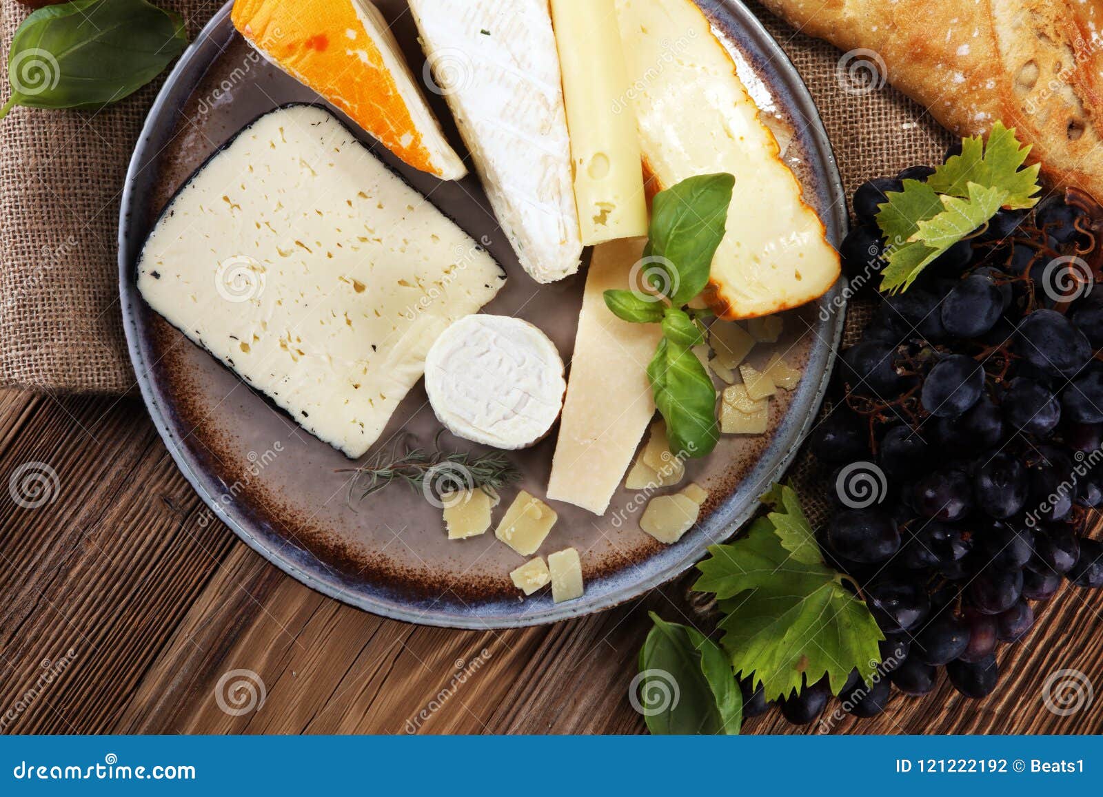 Cheese Platter with Different Cheese on Rustic Plate Stock Photo ...