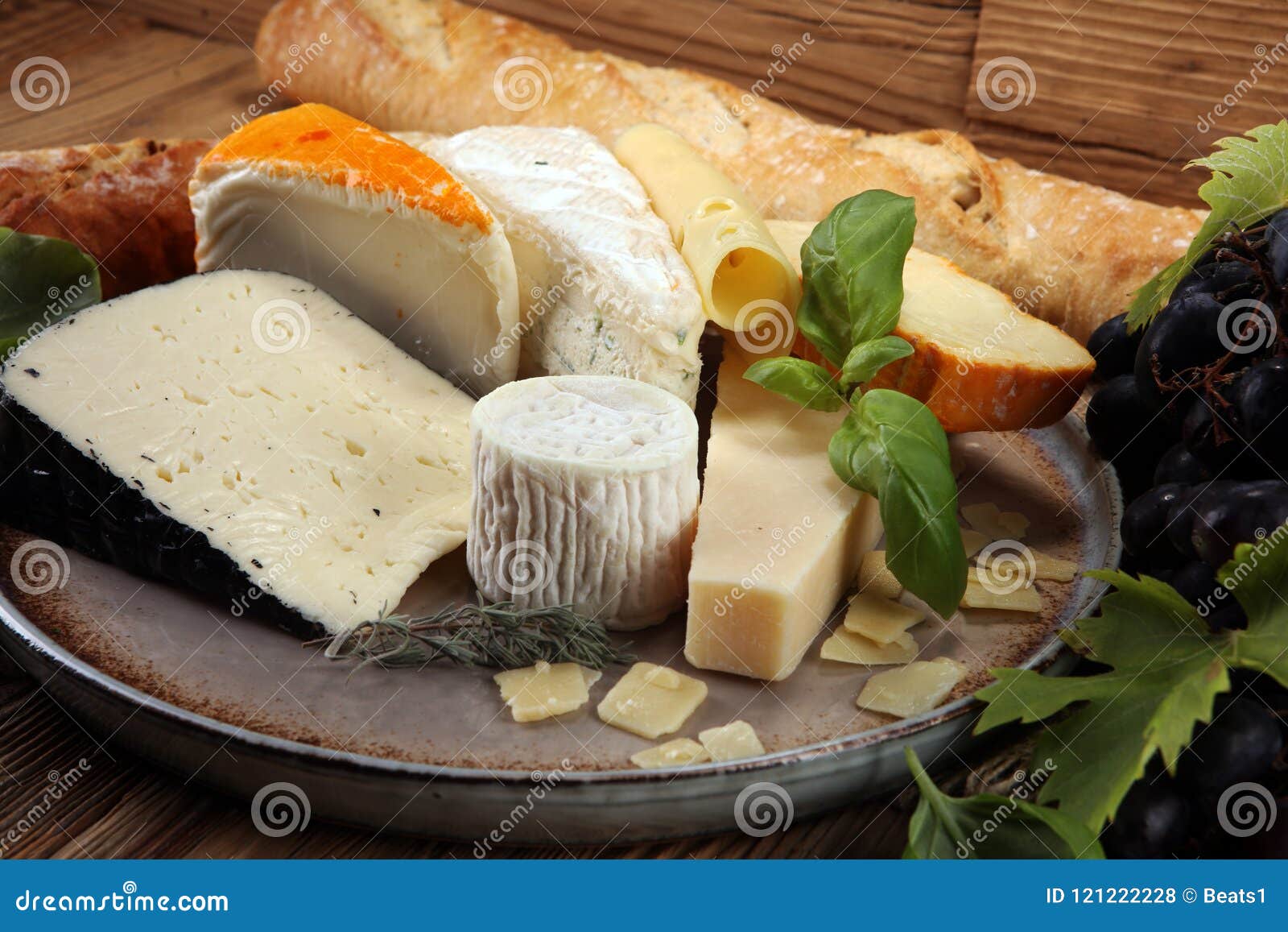 Cheese Platter with Different Cheese on Rustic Plate Stock Photo ...