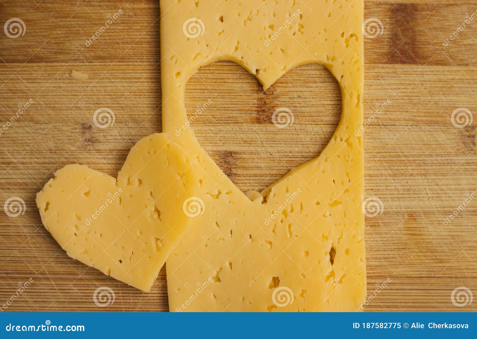 Cheese in the Shape of a Heart on a Wooden Board. Grated Cheese in the ...
