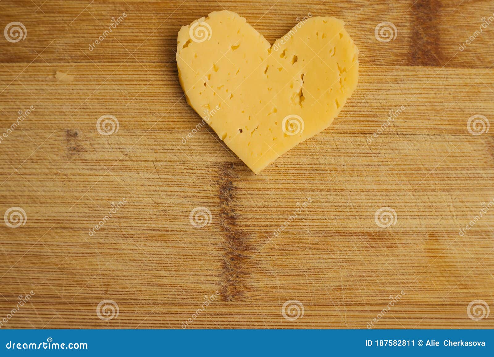 Cheese in the Shape of a Heart on a Wooden Board. Grated Cheese in the ...