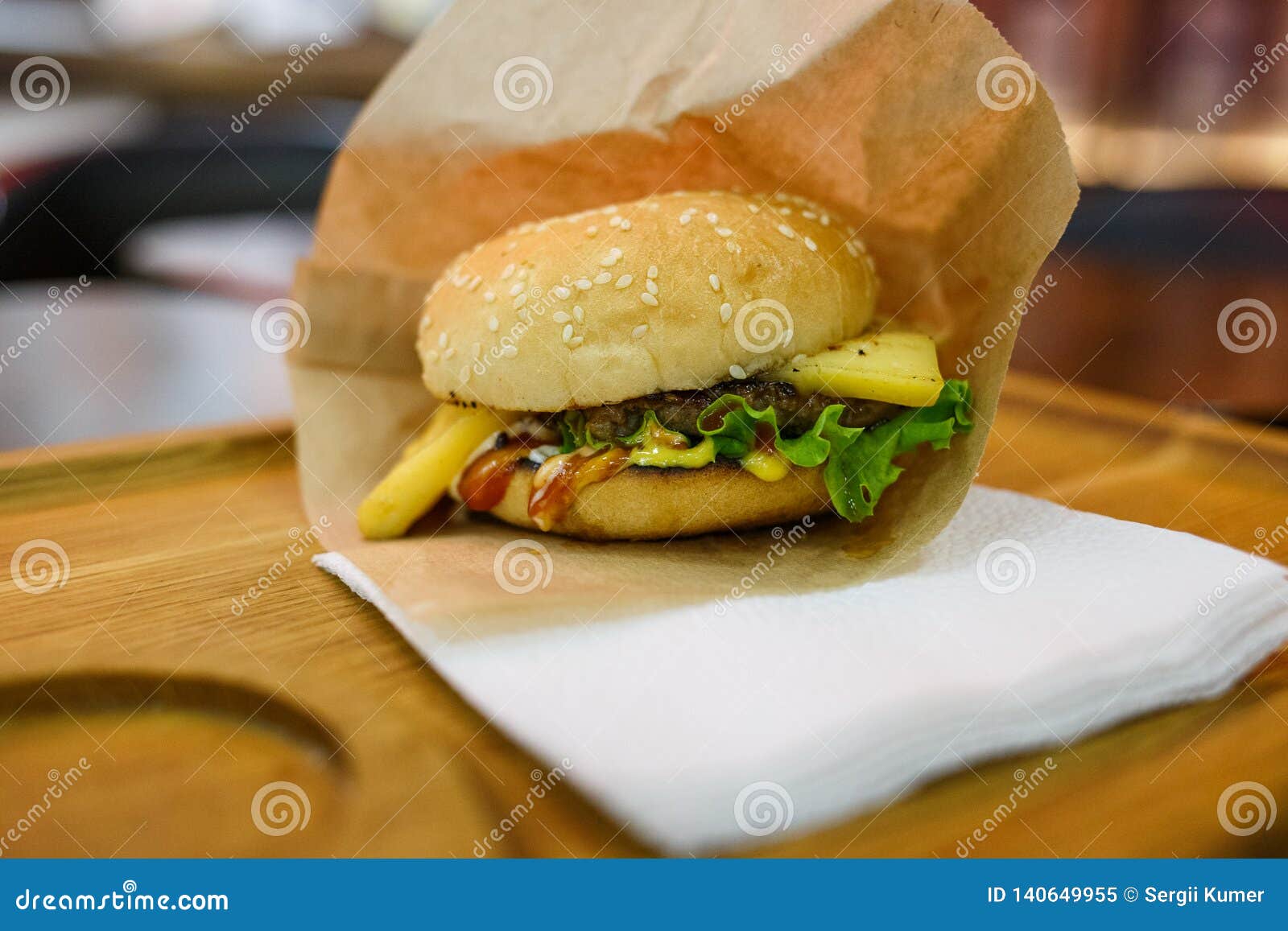Cheeseburger in Paper Wrapping on the Table Stock Image - Image of junk ...