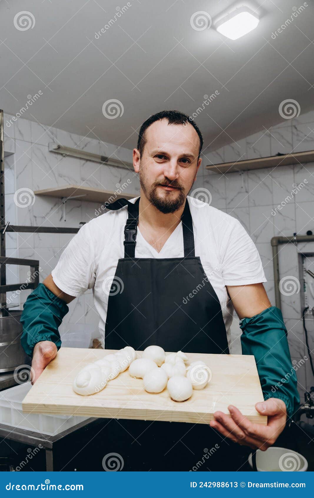 Cheesemaker with a Beard Cooks Mozzarella and Holds Fresh Cheese. Stock ...