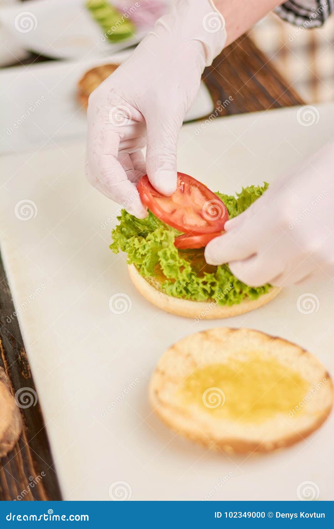 Chef Adding Tomatoes on Burger. Stock Photo - Image of bread, fast ...