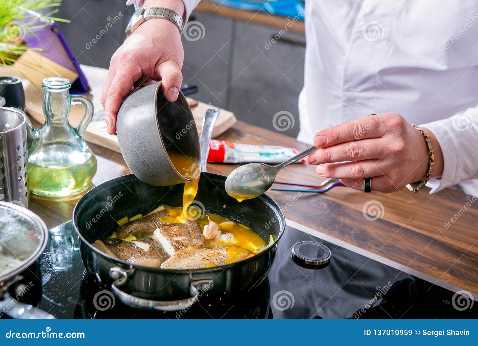 Chef Adds Sauce To The Pan With Halibut. Master Class In The Kitchen ...
