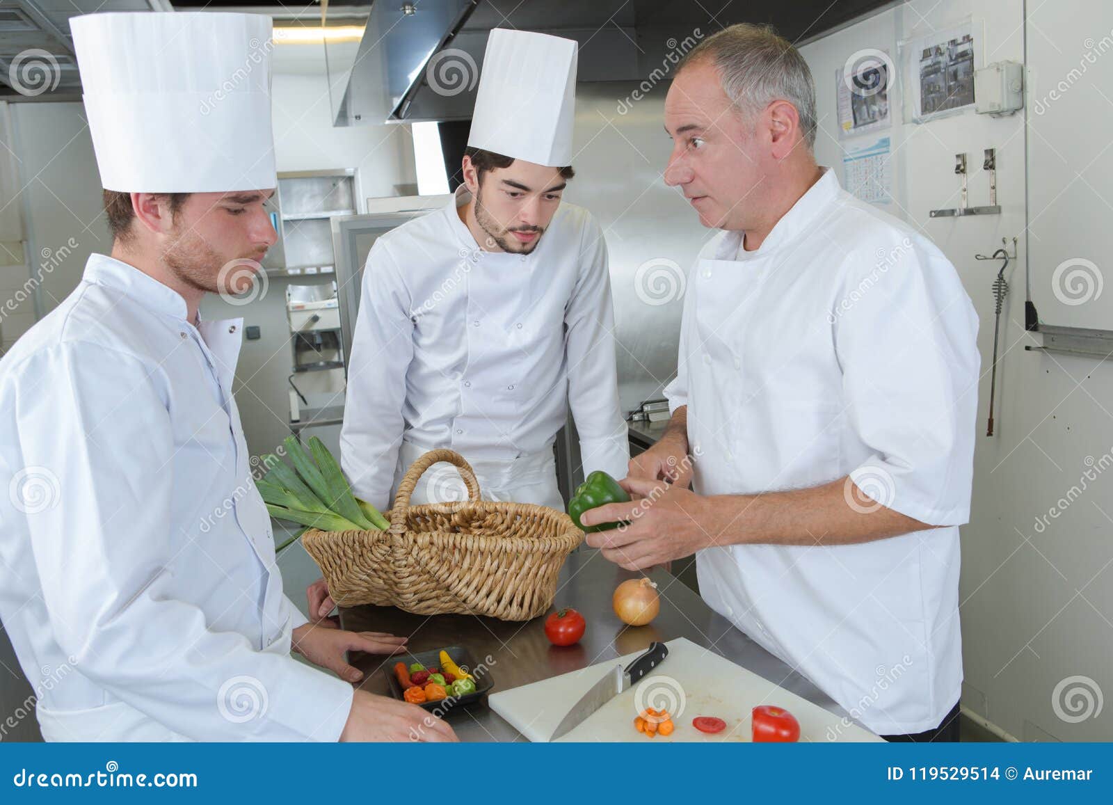 Chef with Apprentices Teaching about Vegetables Stock Photo - Image of ...