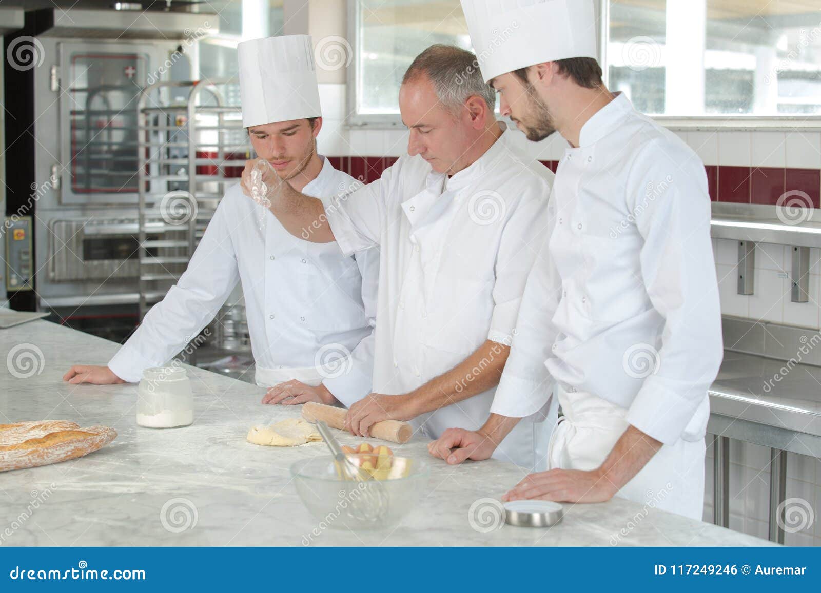 Chef and Apprentices Working at Kitchen Stock Photo - Image of kitchen ...