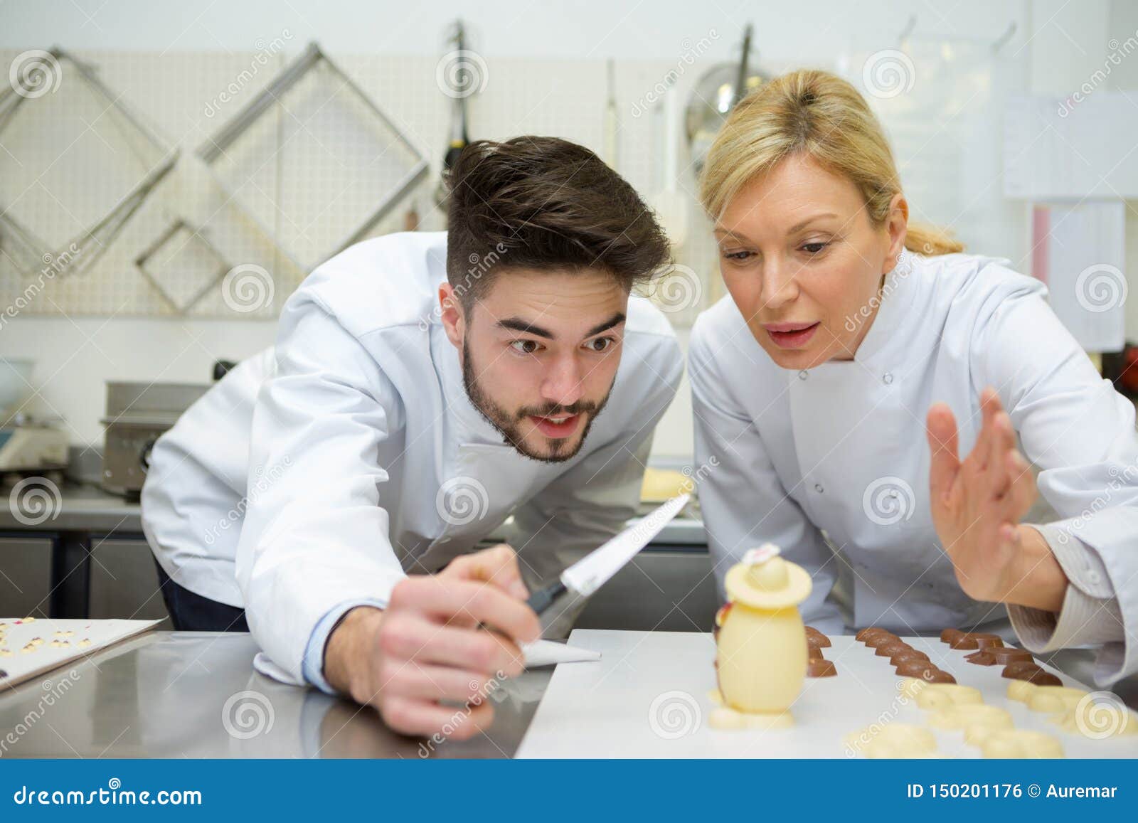 Chef and Assistant Prepare Delicious Chocolates Eggs in Kitchen Stock ...