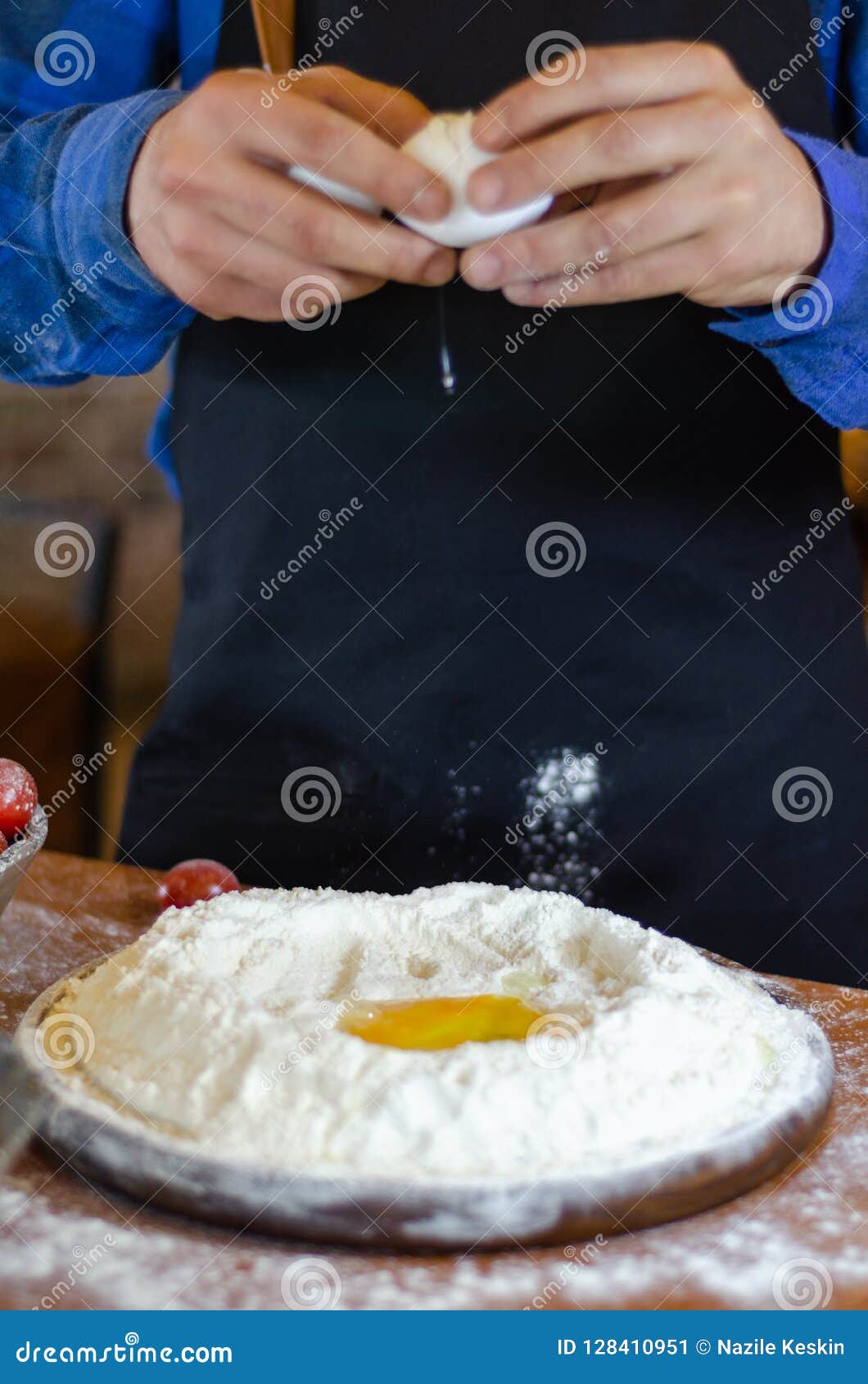 Chef is Breaking Eggs into Flour on Wooden Table. Stock Image - Image ...