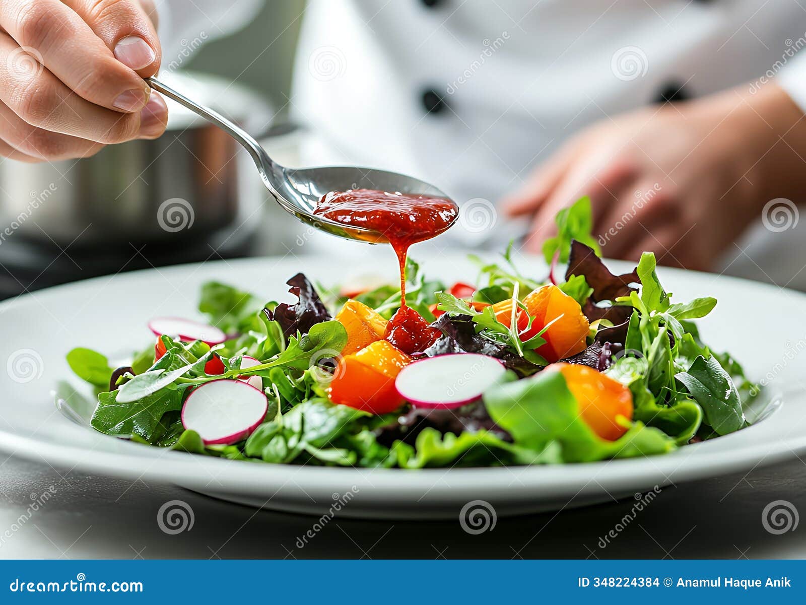 A Chef Carefully Drizzles a Red Dressing Over a Fresh Salad Stock Photo ...