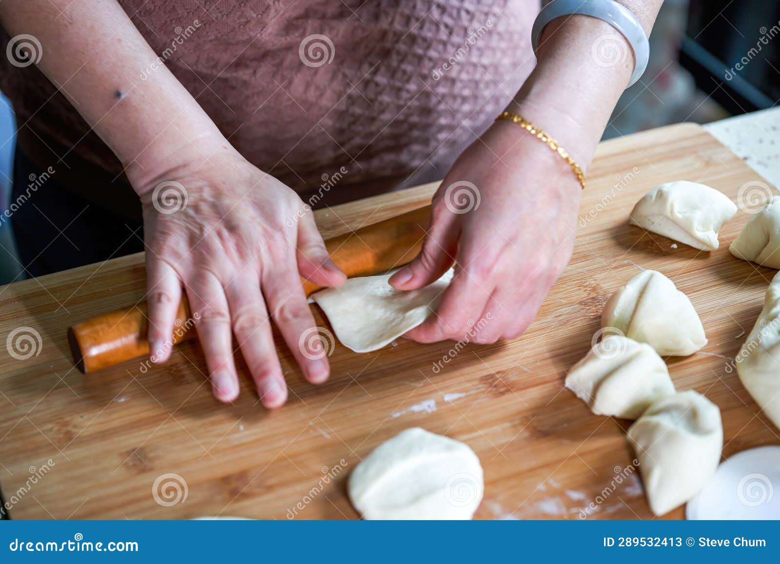 A Chef in a Chinese Kitchen is Making Bun Skins with a Rolling Pin ...