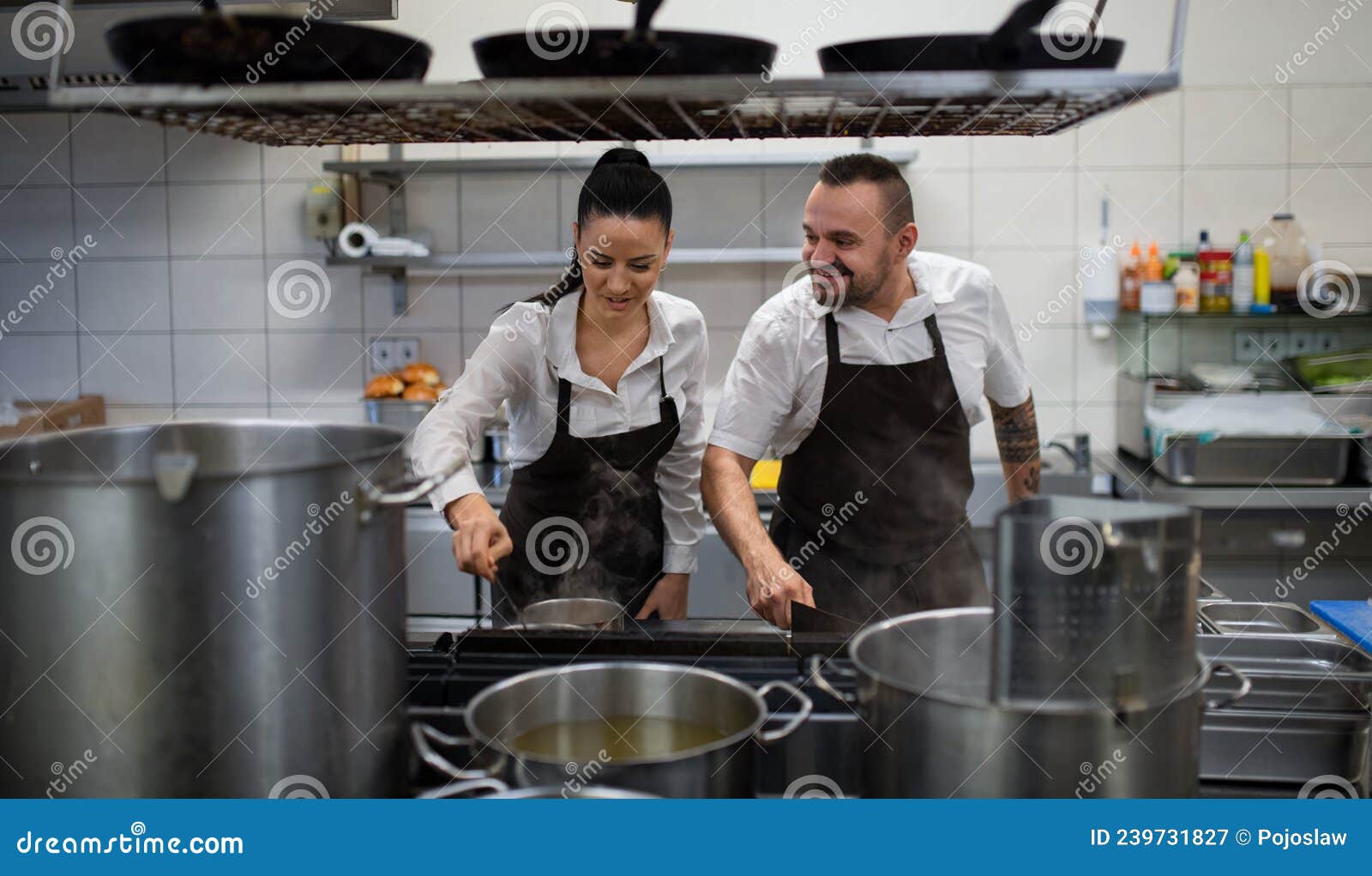Chef and Cook Cooking Together Indoors in Restaurant Kitchen. Stock ...