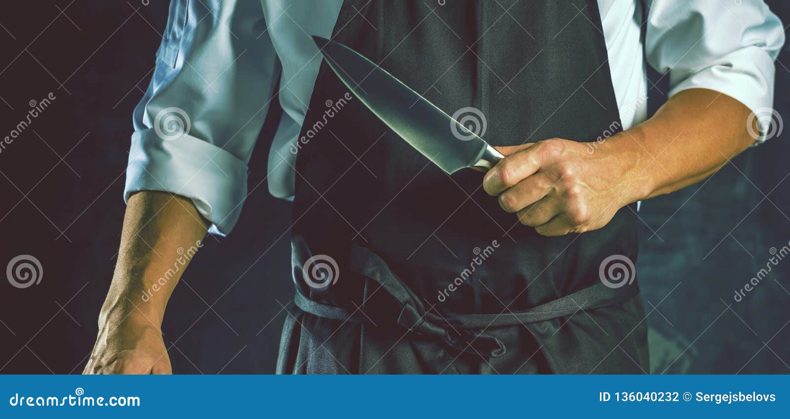 Chef Cook Holds a Knife Over Dark Grey Background Stock Photo - Image ...